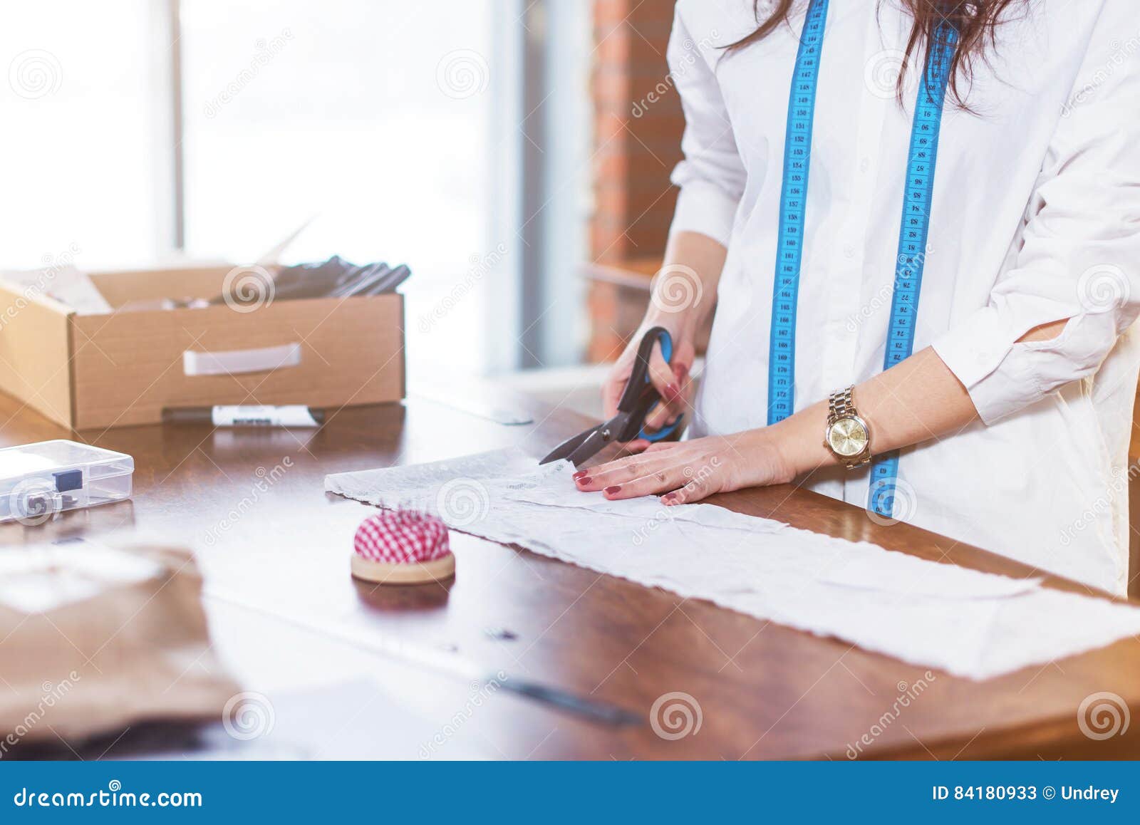 Close-up Picture of Tailor S Hands Cutting Cloth with Scissors on Table ...