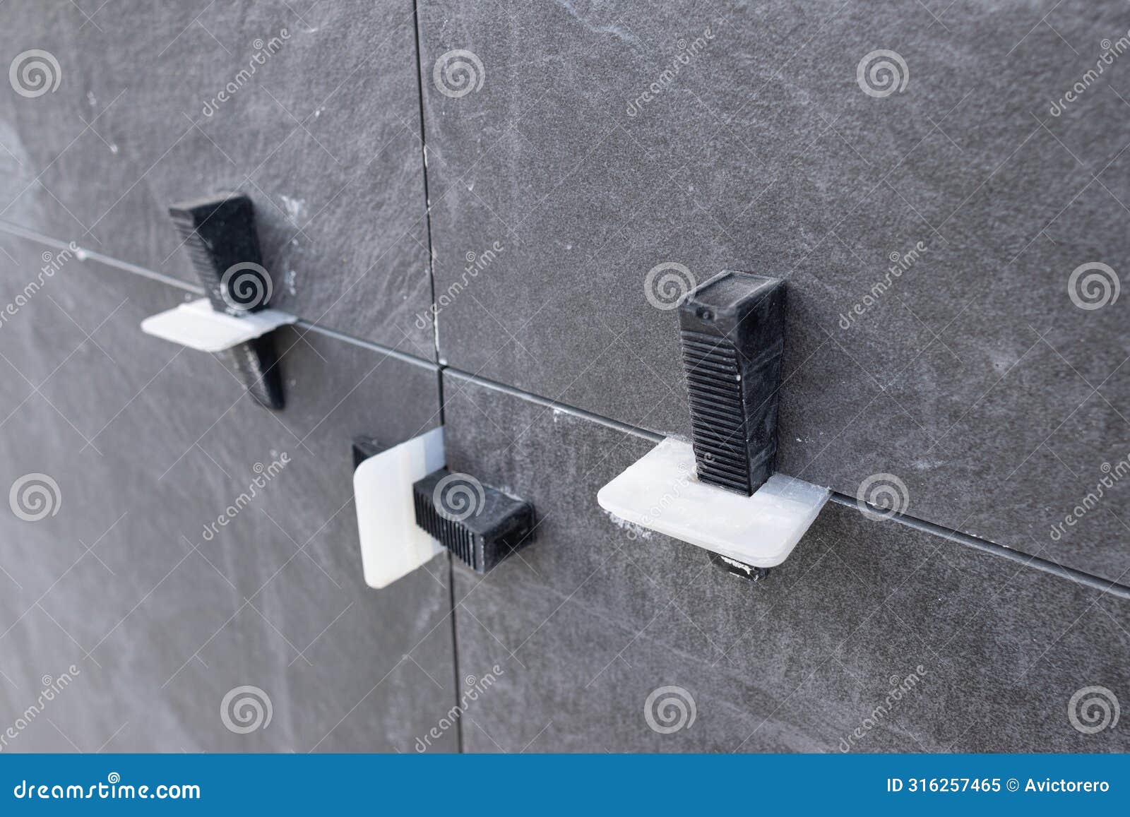 Close Up of Plastic Tile Leveling System Clips and Wedges on Installed ...