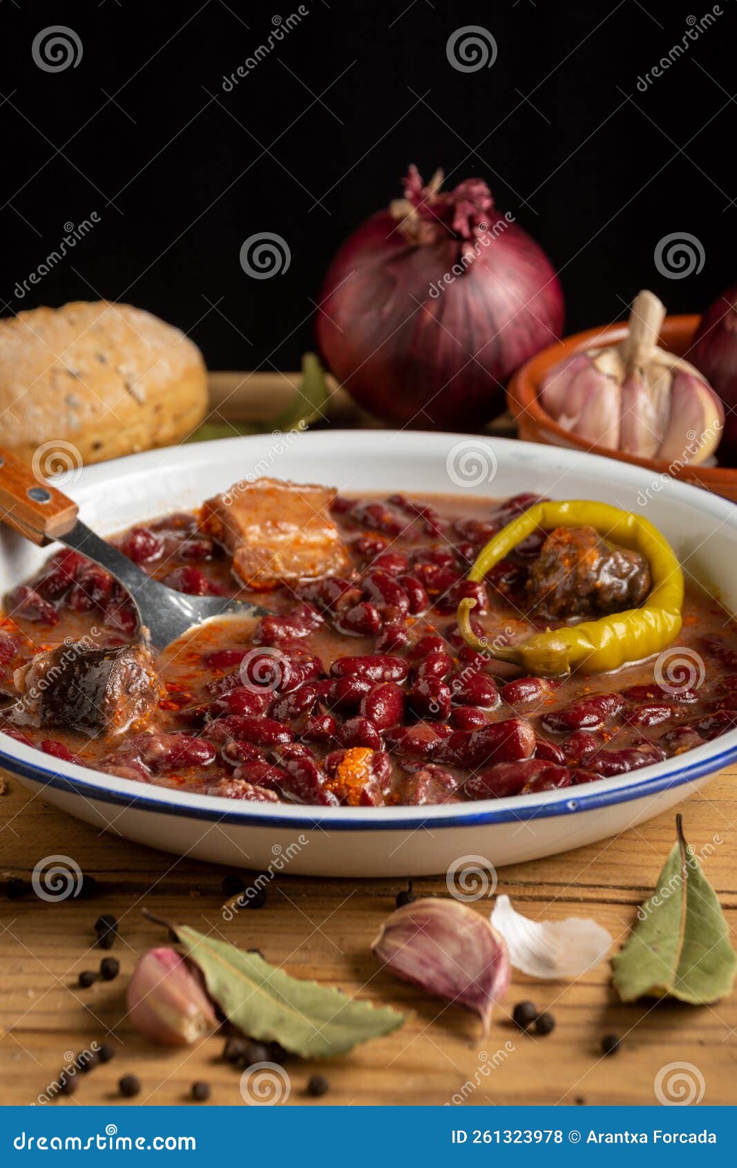 Close-up of Plate of Basque Beans with Spoon on Rustic Table with ...