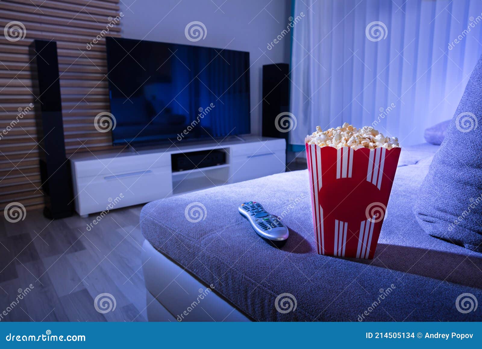 Close-up of Popcorn and Remote Control on Couch Stock Photo - Image of ...