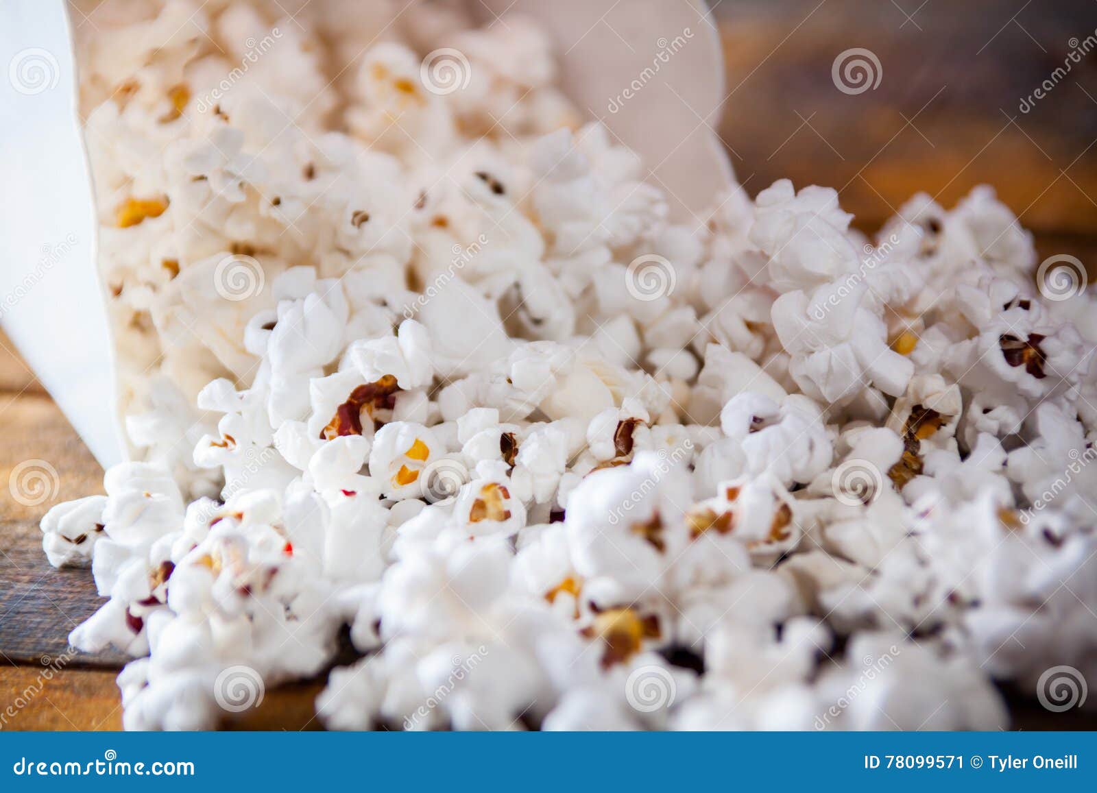 Close Up of Popcorn Spilled Out on a Wooden Table with Selective Stock ...