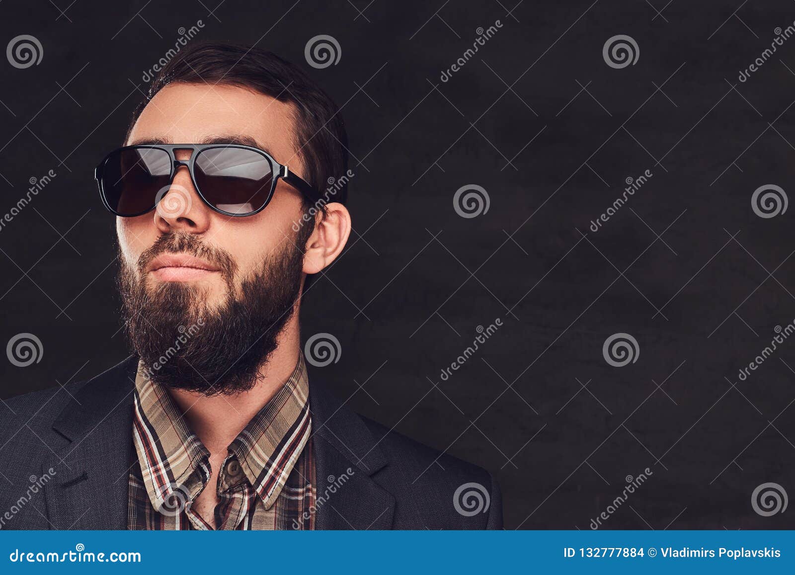 Close Up Portrait Of A Bearded Man Wearing A Suit And Sunglasses Stock