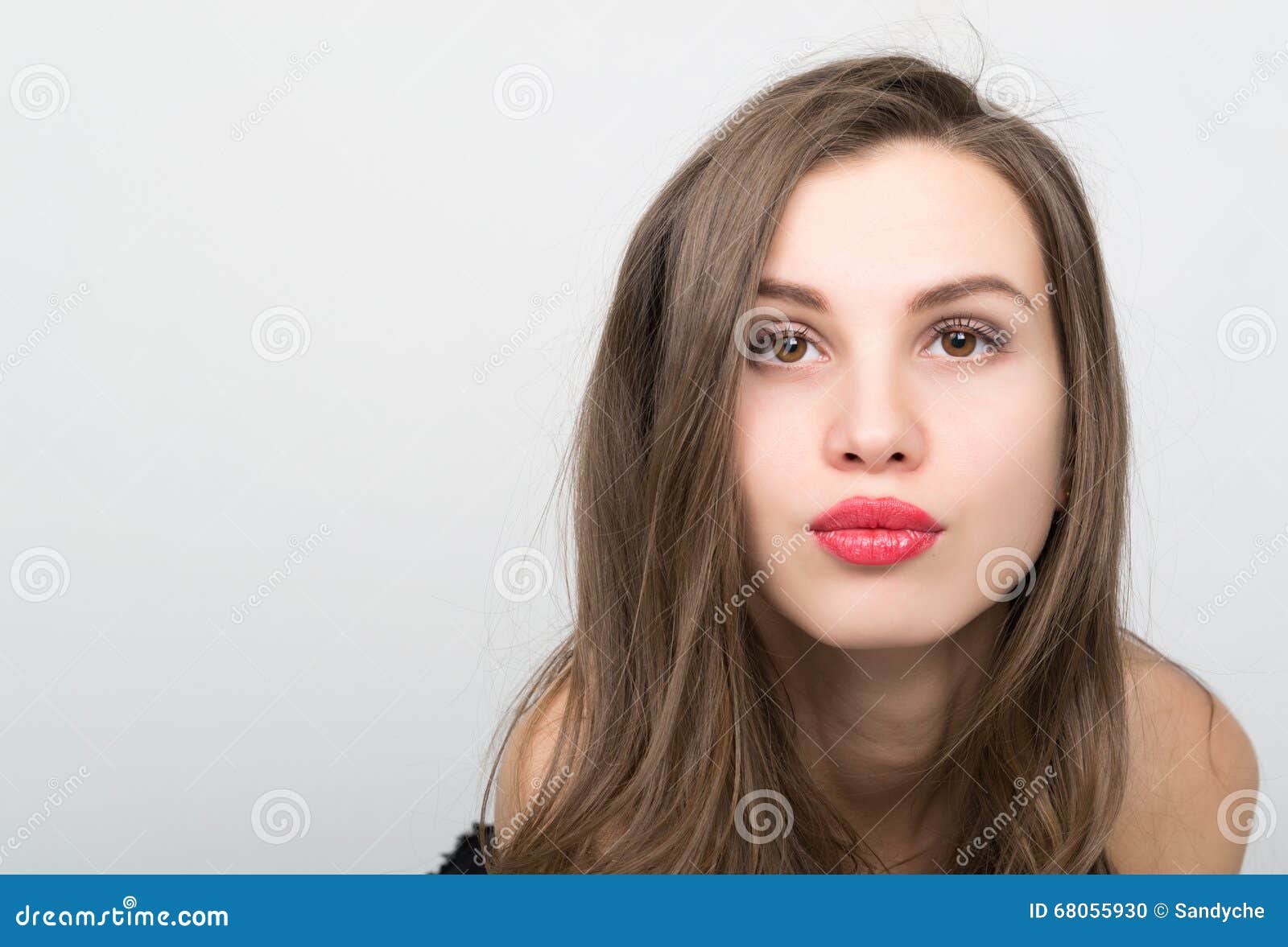 Close Up Portrait Of A Beautiful Brunette Girl With Red Lips Expresses