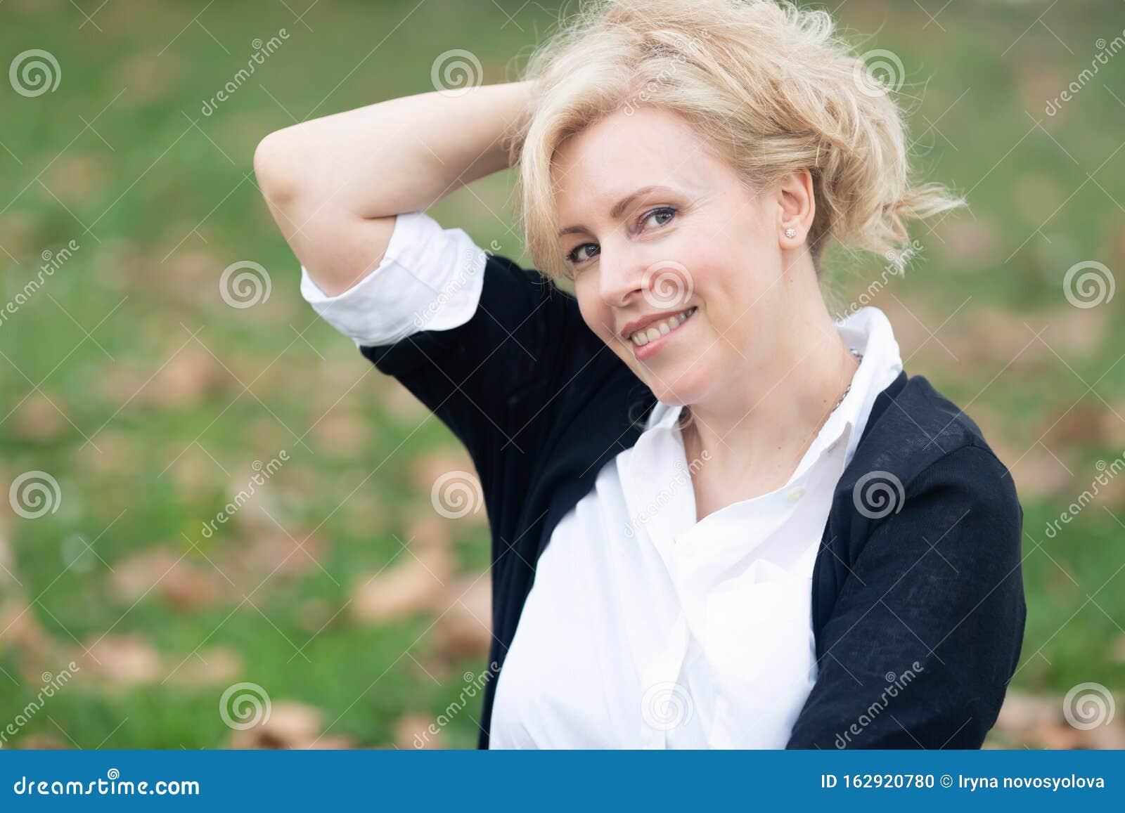 A Close Up Portrait Of Caucasian Woman With Long Blond Hair Looking
