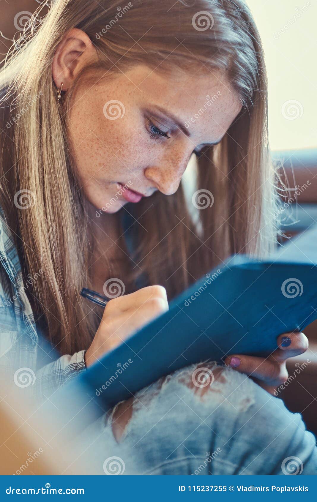 Portrait of a Charming Girl Making Notes in a Notepad, Sitting in a Car ...