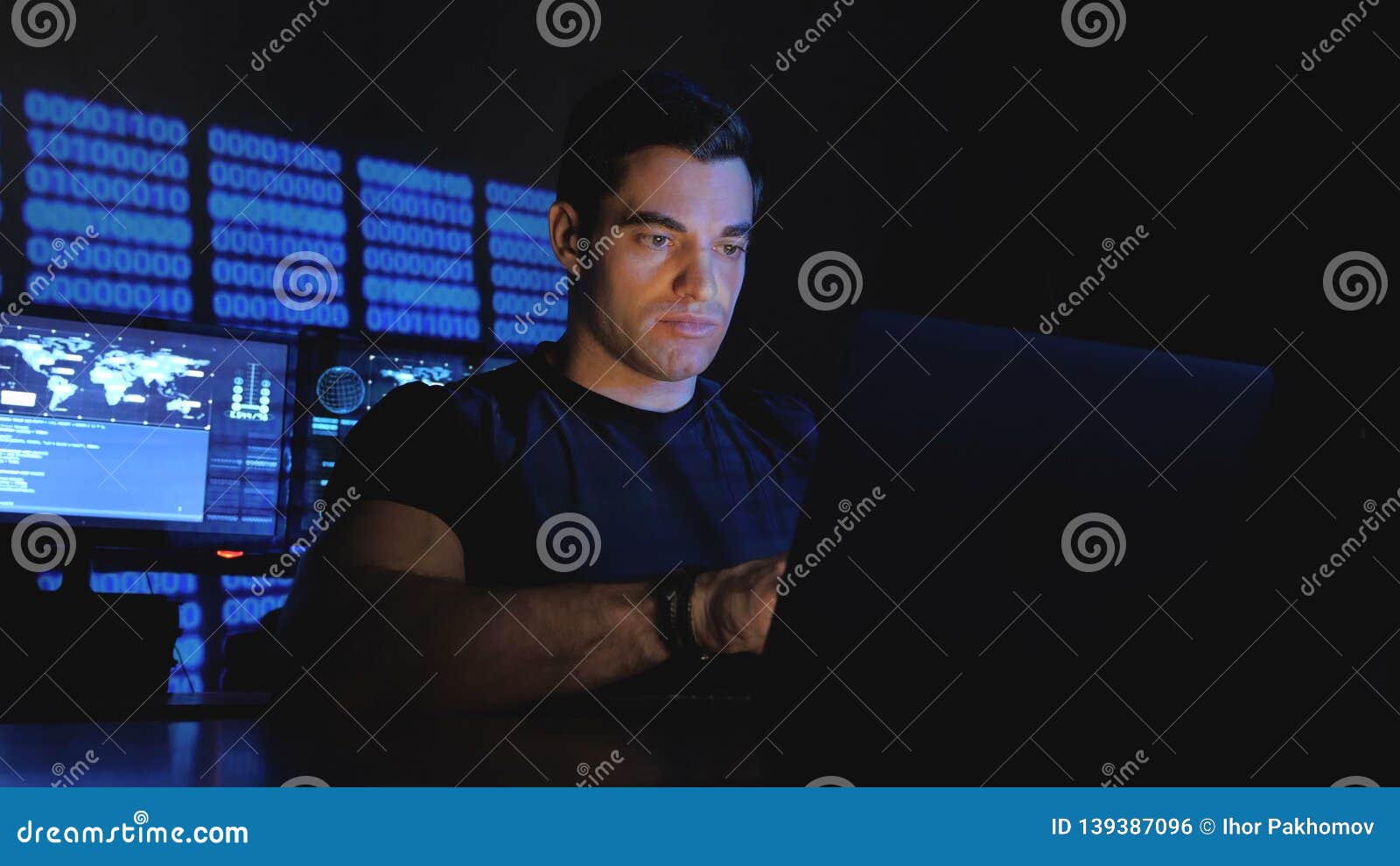 Portrait Of Developer Hacker Programmer Working On Computer In A Data Center Filled With Monitor