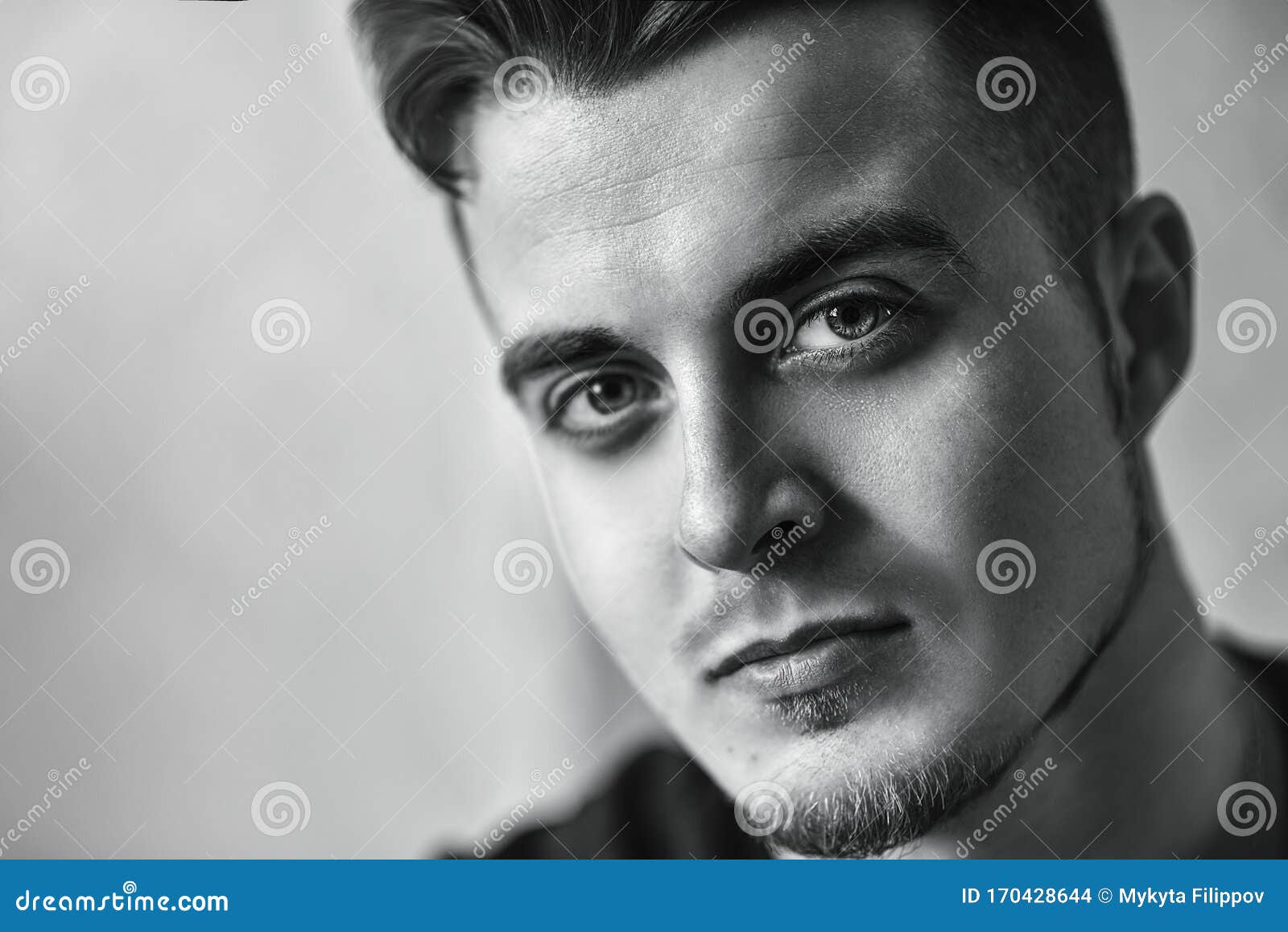 Close-up Portrait of Handsome Young Man with Serious Face Looking at ...
