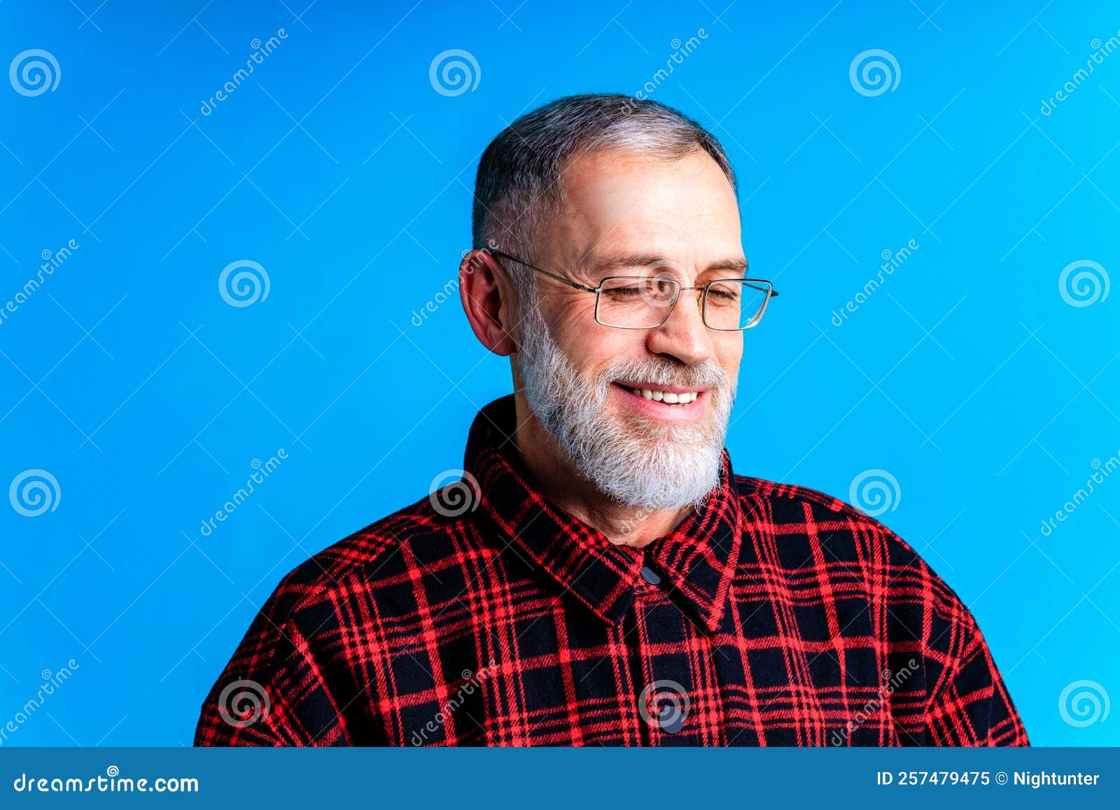 Close-up Portrait of Intelligent Shy Man Looking Down in Blue Studio ...