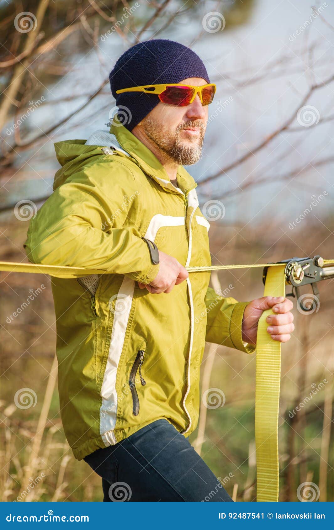 Close-up Portrait of a Man Adjusting Slacklining Equipment before ...