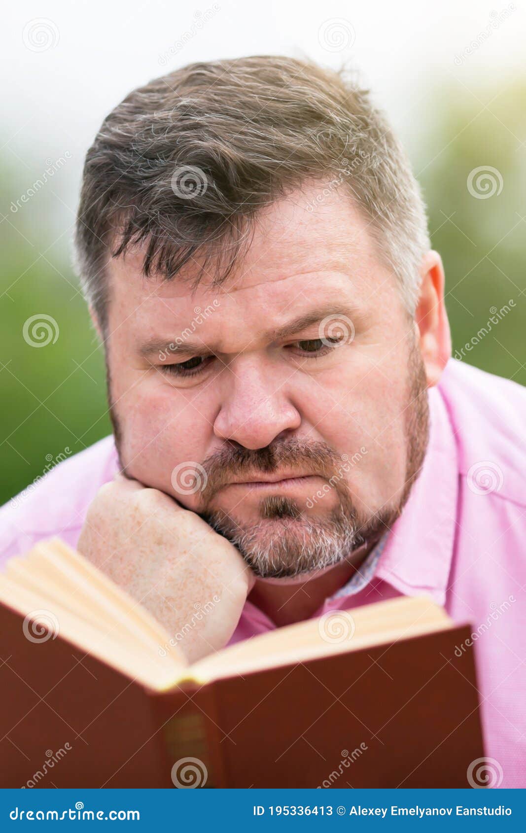 Close-up Portrait of a Man with a Beard Reading a Book. Stock Image ...