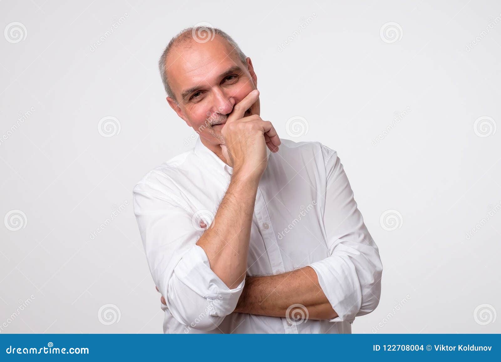 Close Up Portrait Of Mature Hispanic Man Laughing And Covering His