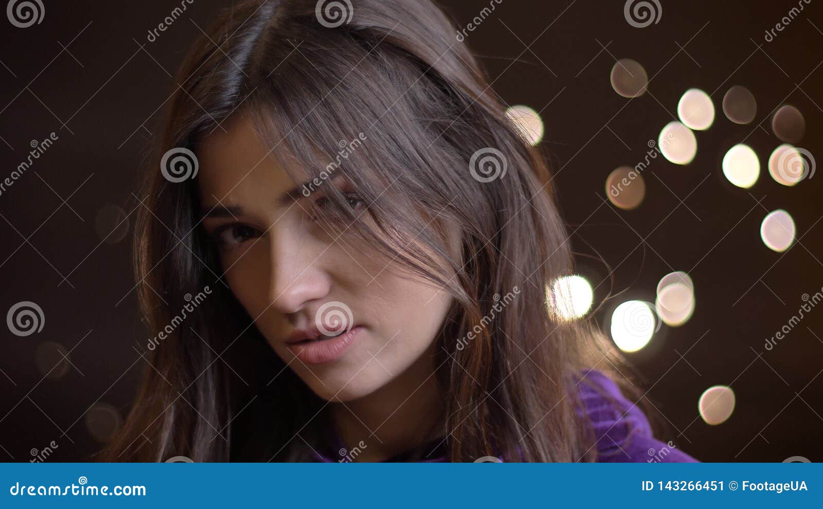 Close Up Portrait Of Pretty Caucasian Brunette Girl Watching Seriously
