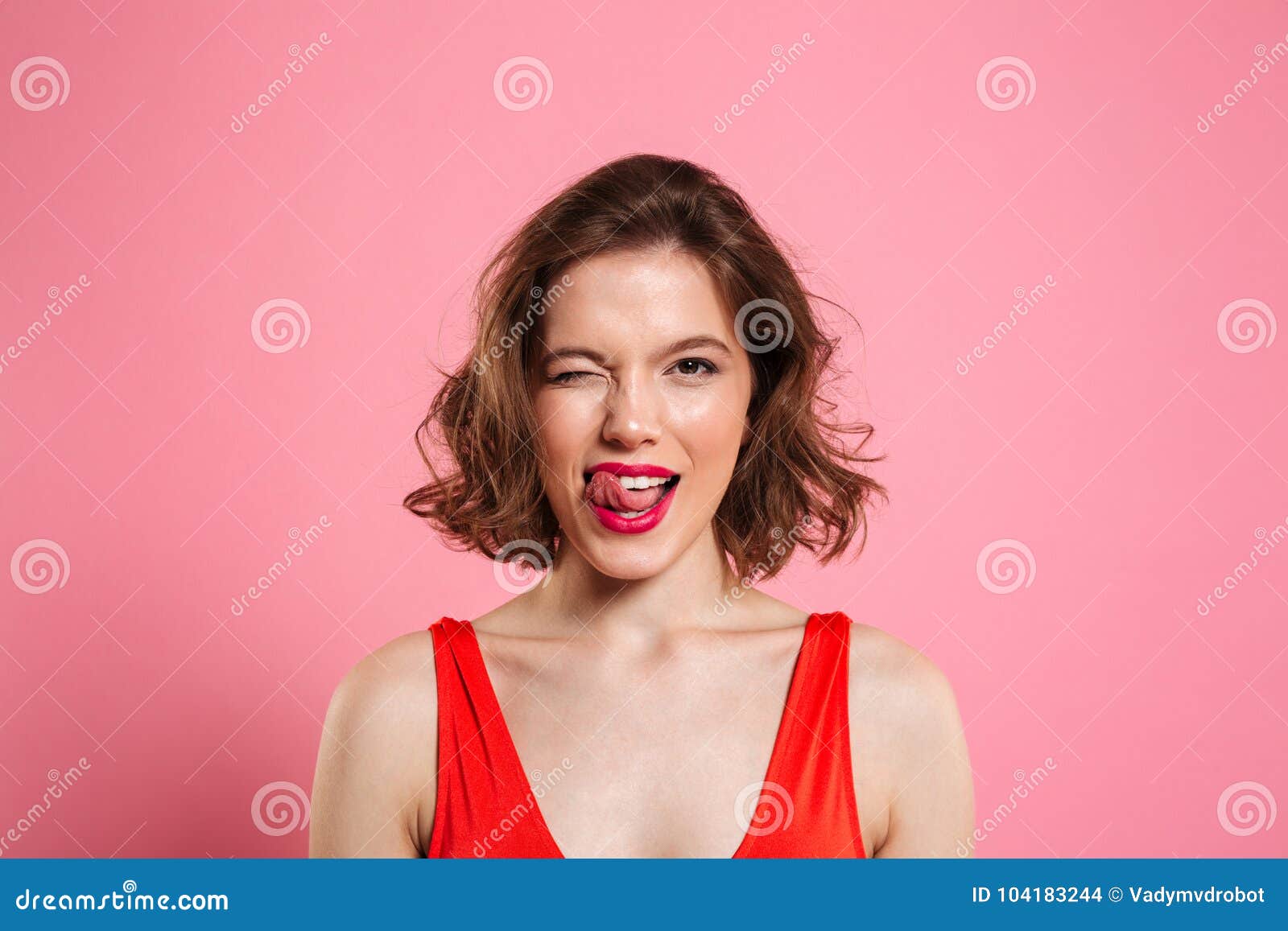 Close Up Portrait Of Pretty Playful Woman Winks One Eye Showing Stock