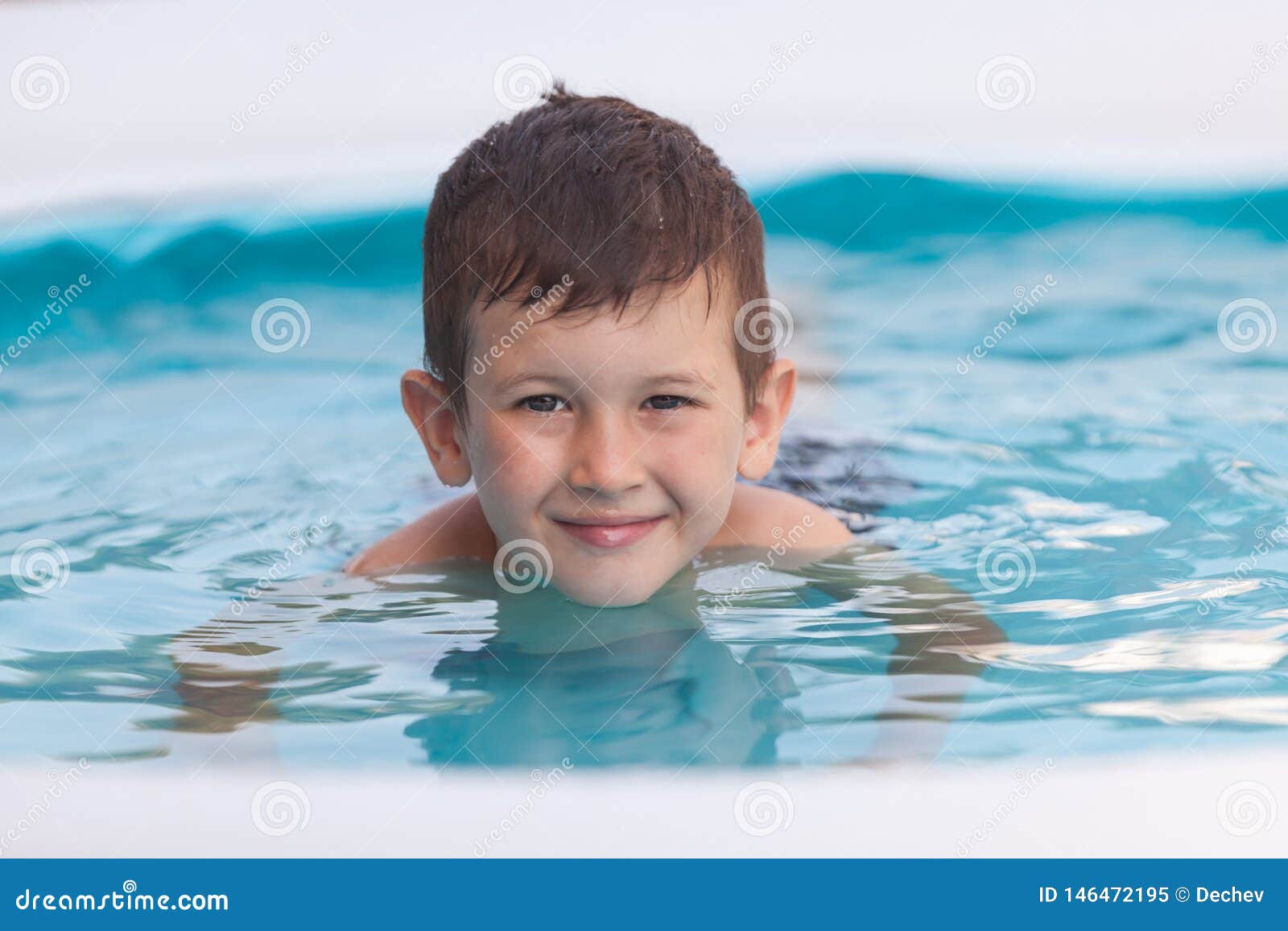 Close Up Portrait of a Smiling Young Boy in the Pool. Vacations Concept ...