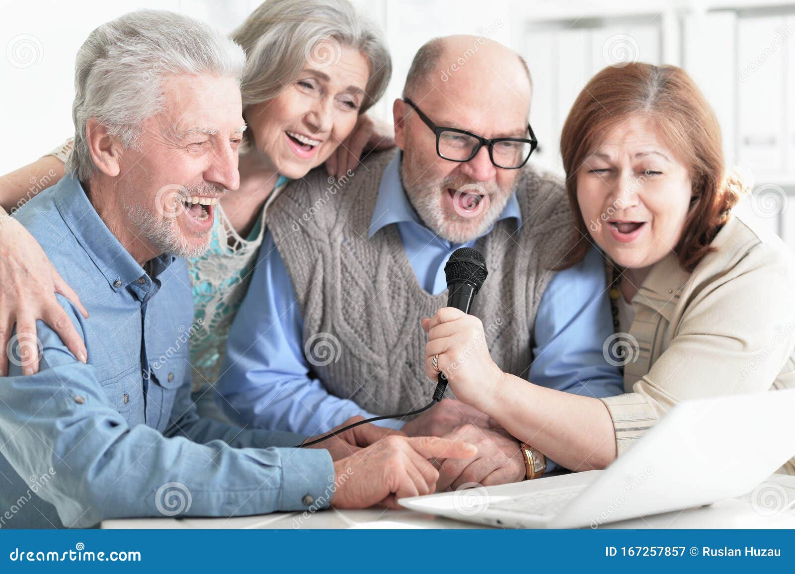 Close Up Portrait of Two Senior Couples Singing Karaoke with Microphone ...