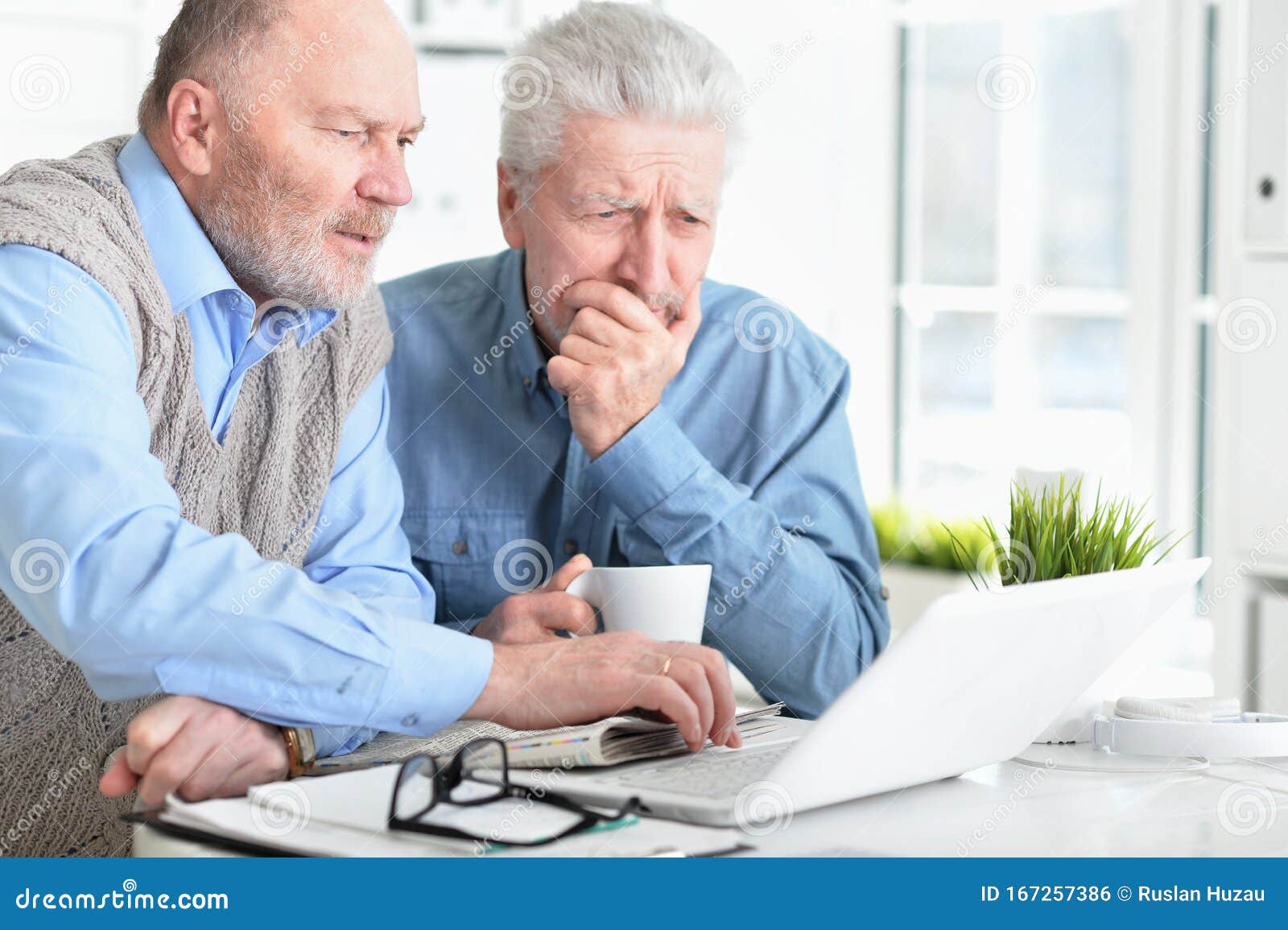 Close Up Portrait of Two Senior Men Sitting at Table and Using Laptop ...