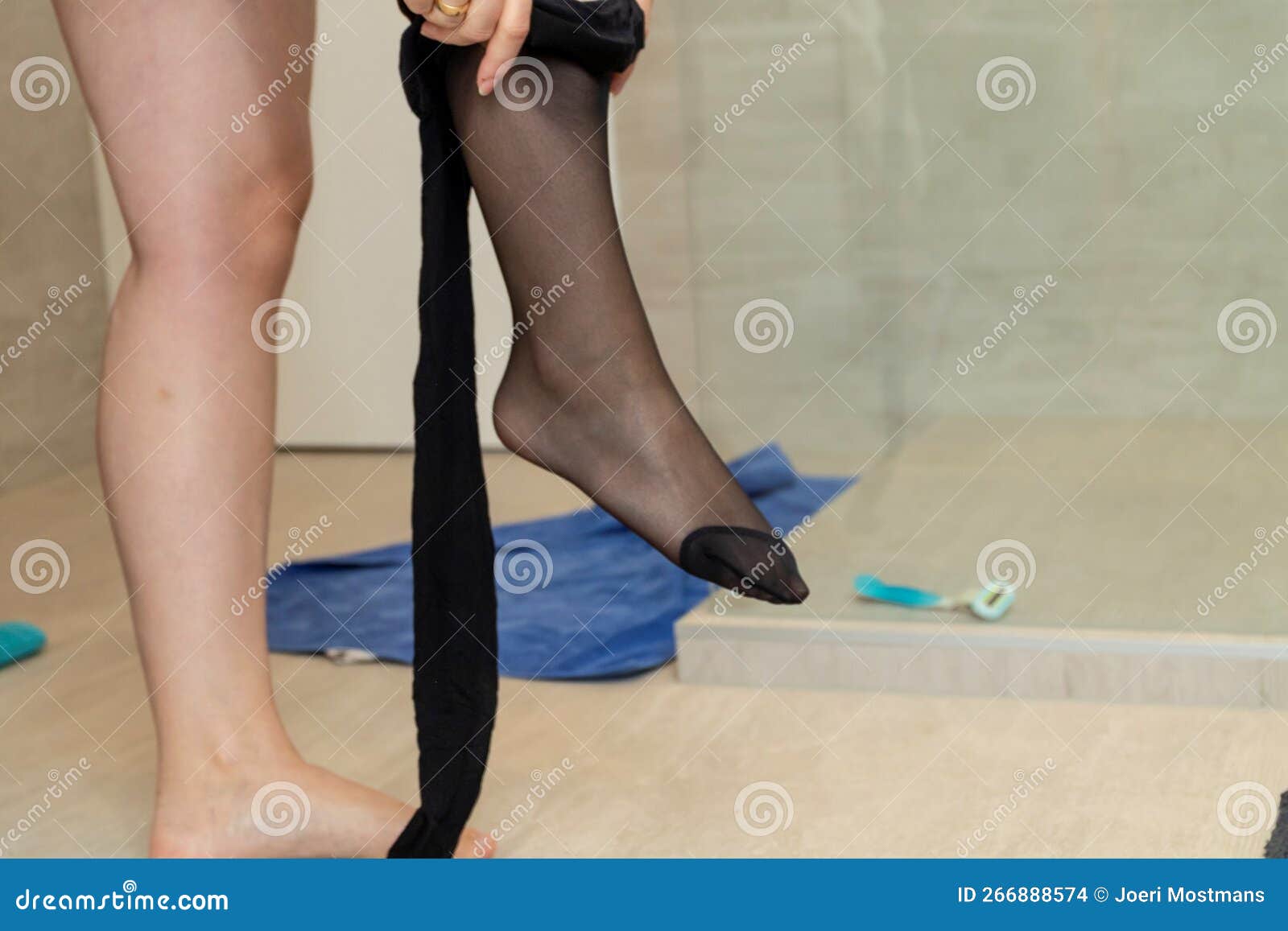 A Close Up Portrait Of A Woman Sensually Pulling Up Sheer Black Nylon