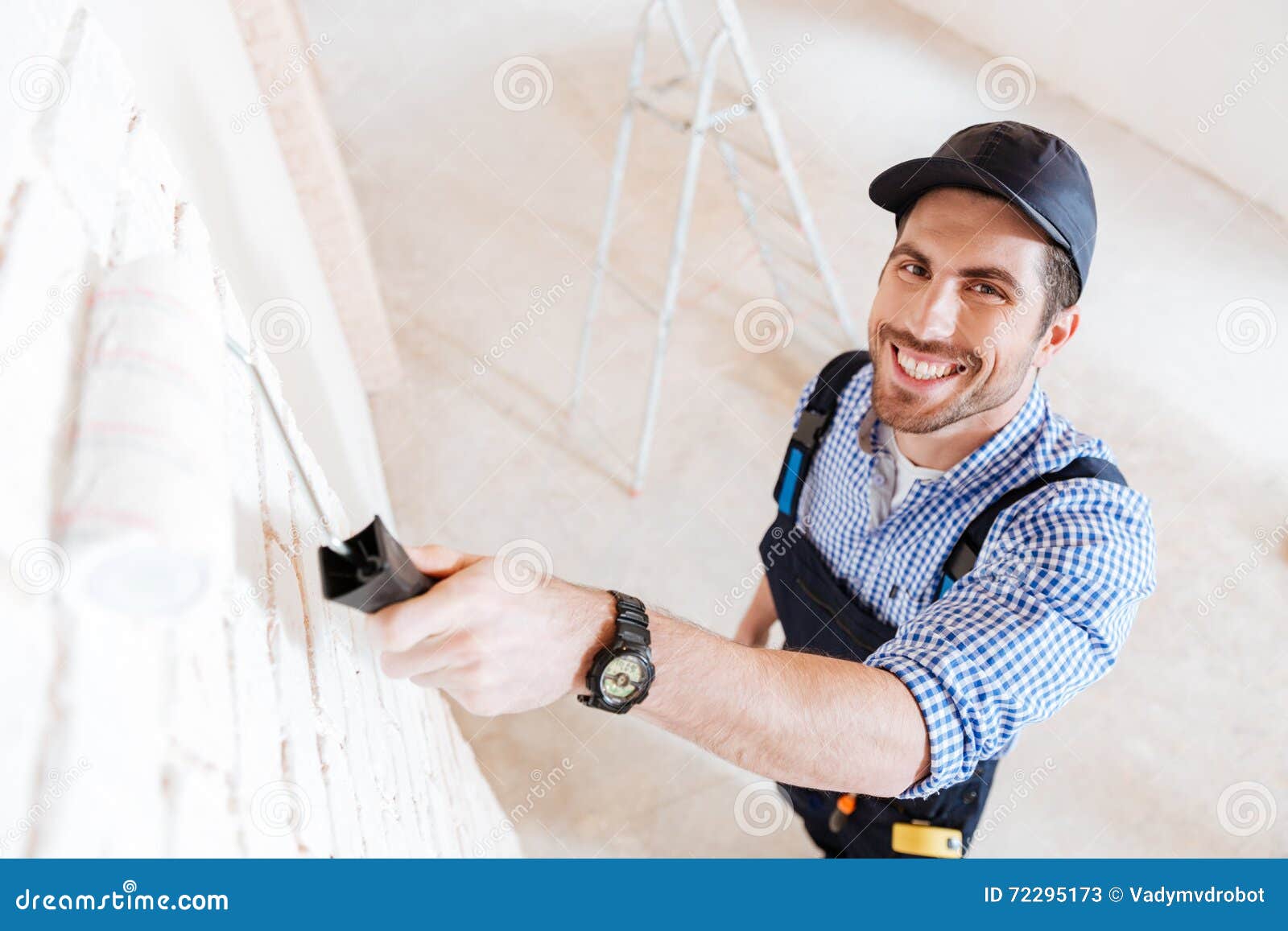 Close-up Portrait of Young Handsome Builder with Paint Roller Stock ...