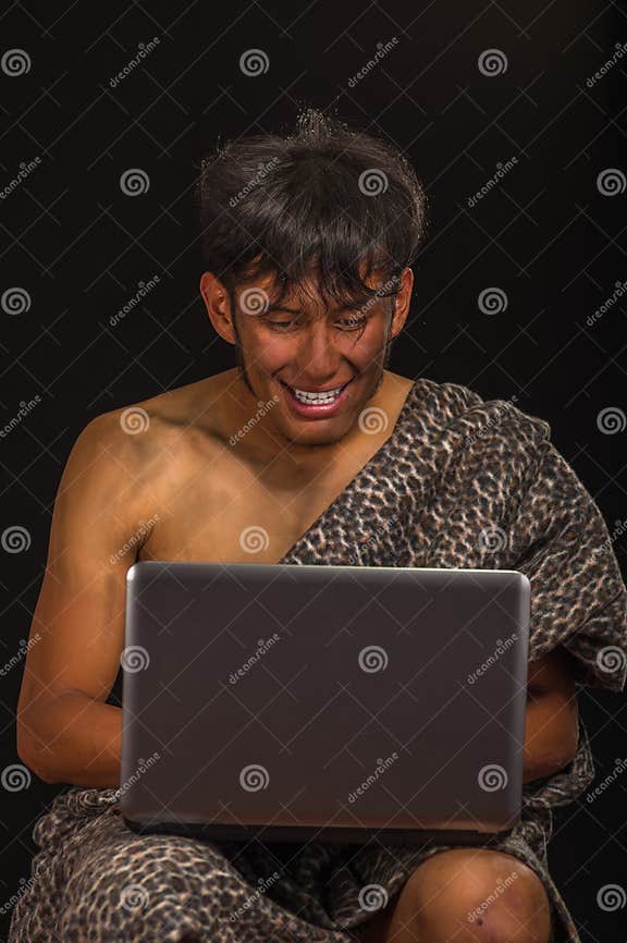Close Up of Prehistoric Man Working in His Computer, in a Black ...