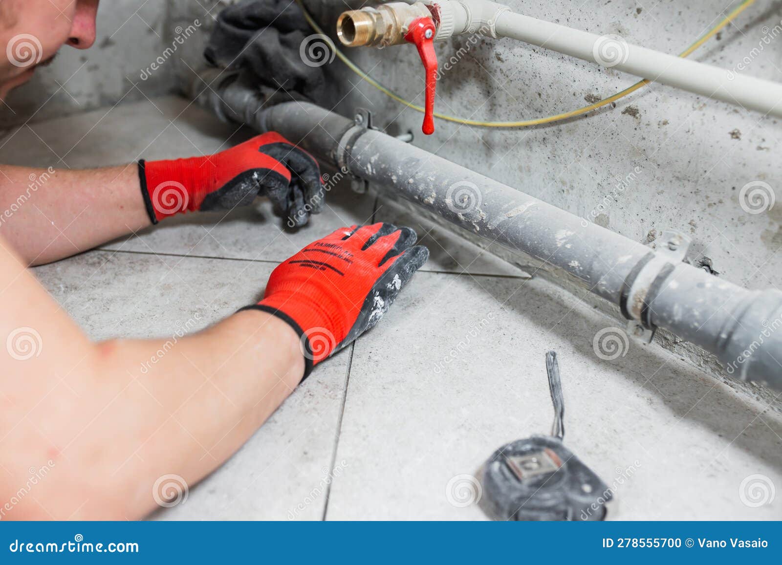 Close-up of the Process of Installing Tiles on the Floor and Wall Stock ...
