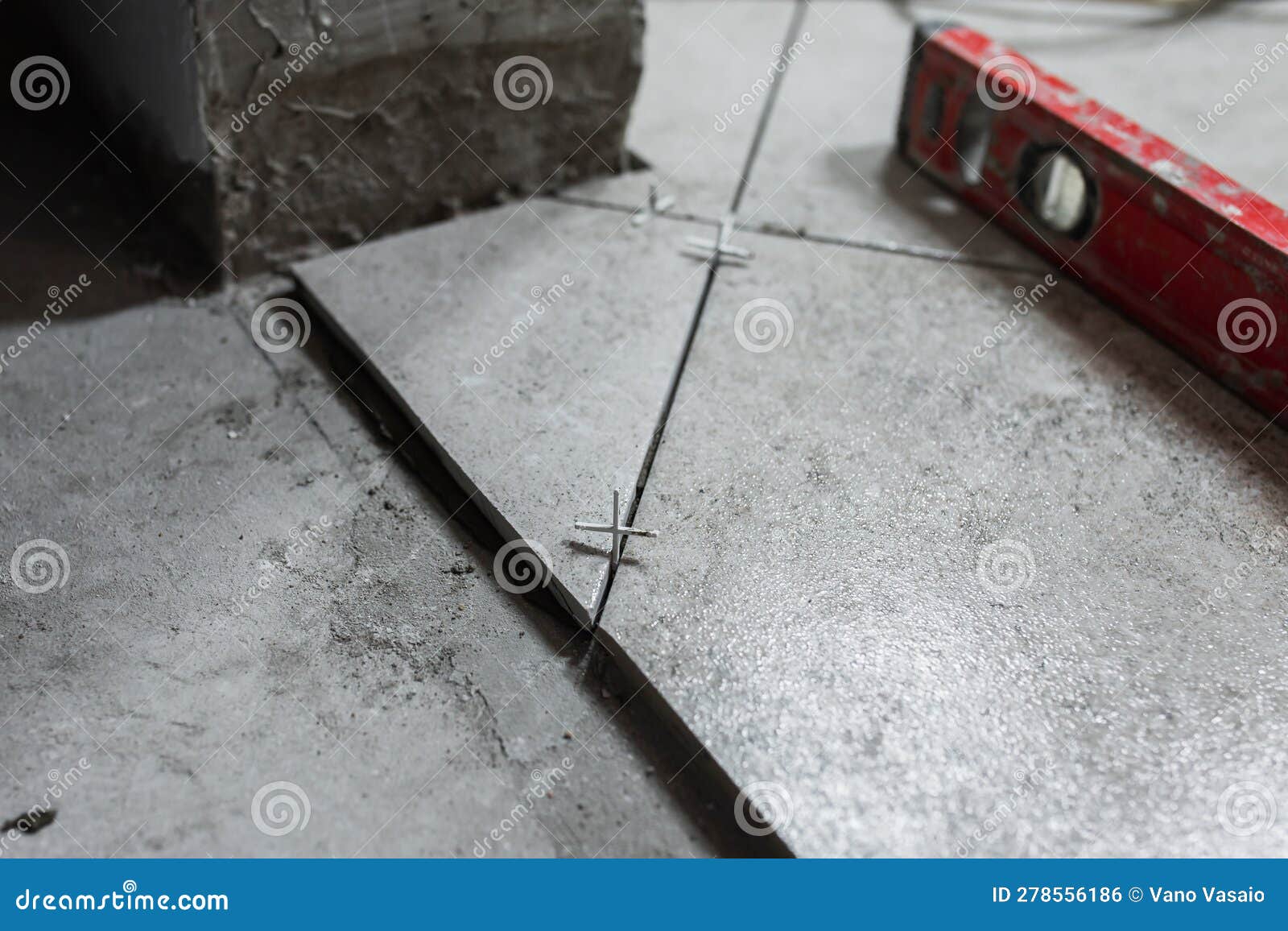 Close-up of the Process of Installing Tiles on the Floor and Wall Stock ...
