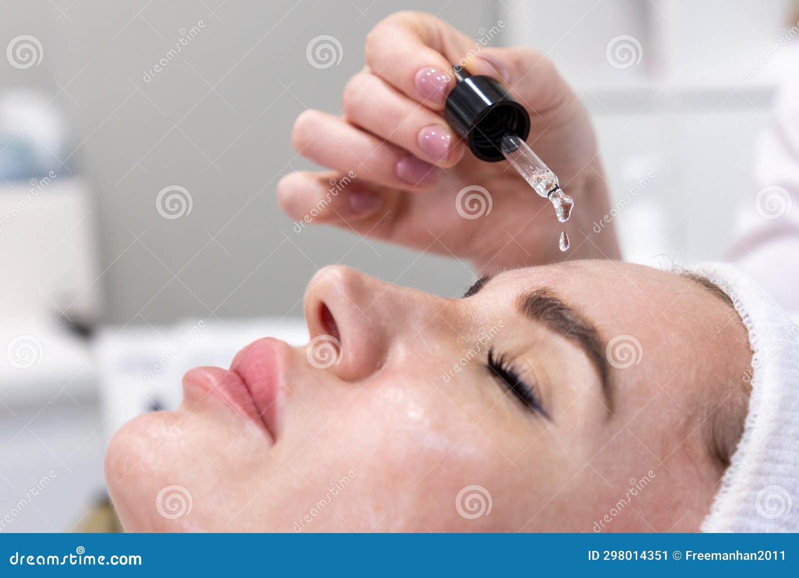Close Up Of Professional Cosmetologist Applies Moisturizing Serum To