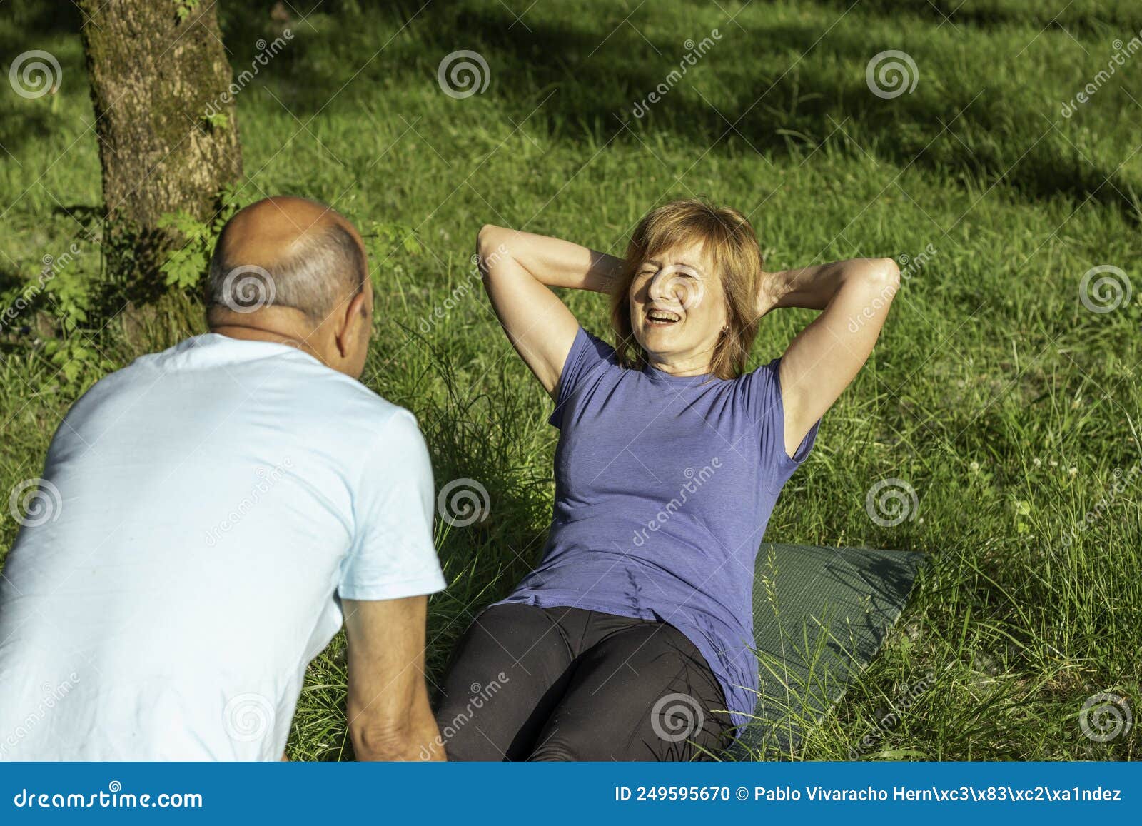 Close Up Protrait Of Two Older Men And Woman Exercising While Having