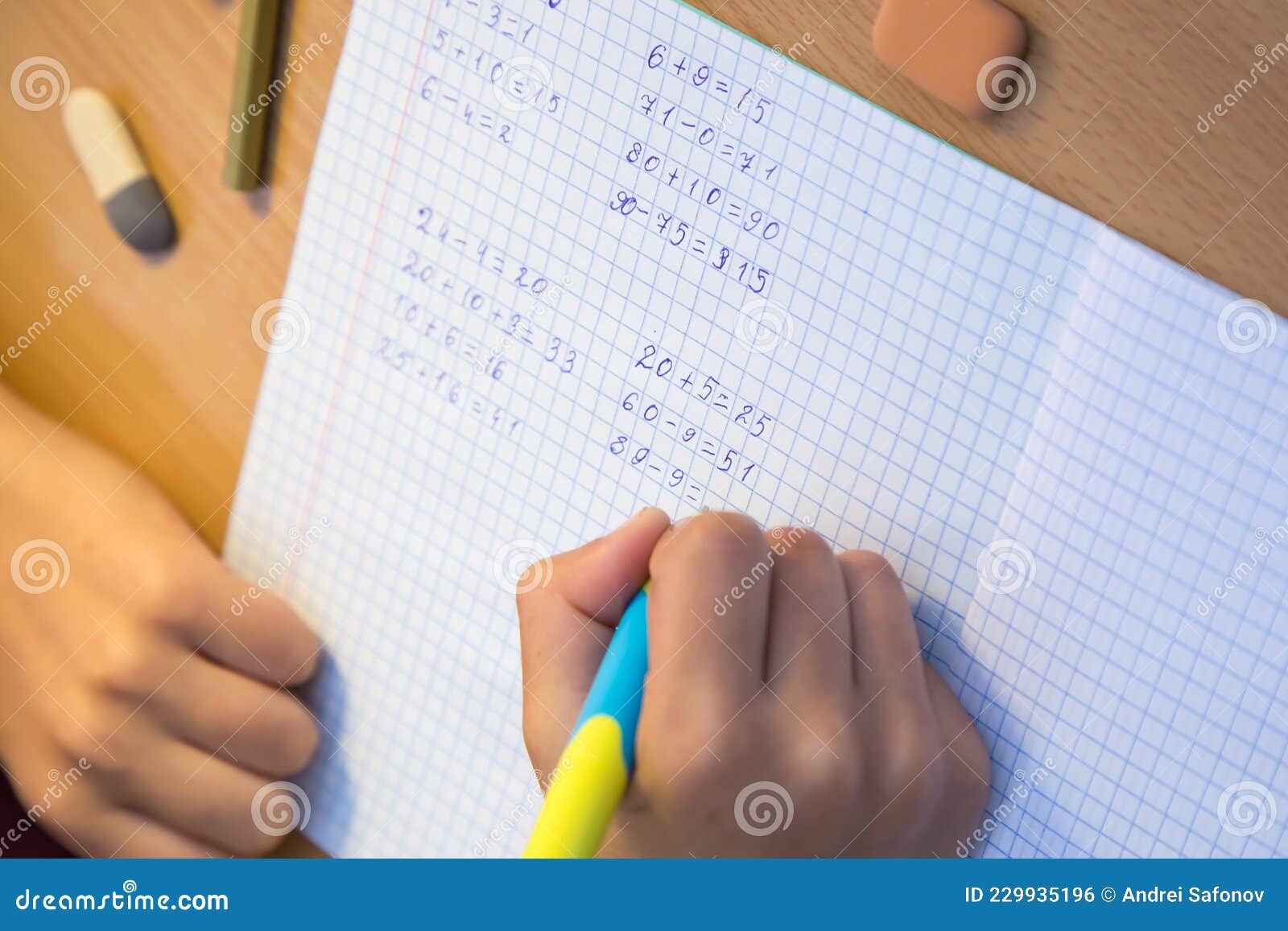 Close-up Pupil& X27;s Hand Solves Math Examples in a Notebook. Stock ...