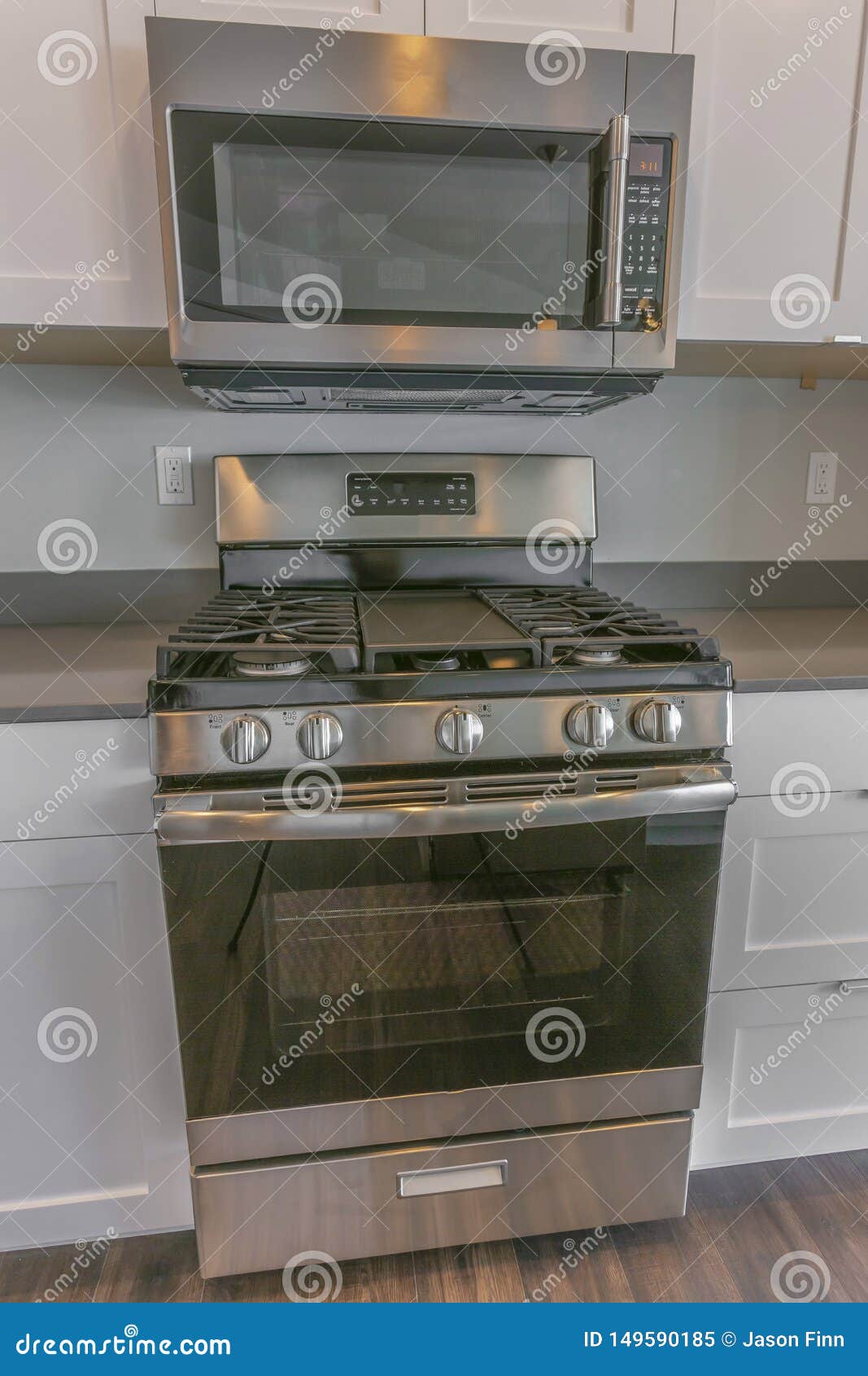 Close Up of a Range and Microwave Inside the Modern Kitchen of a House ...