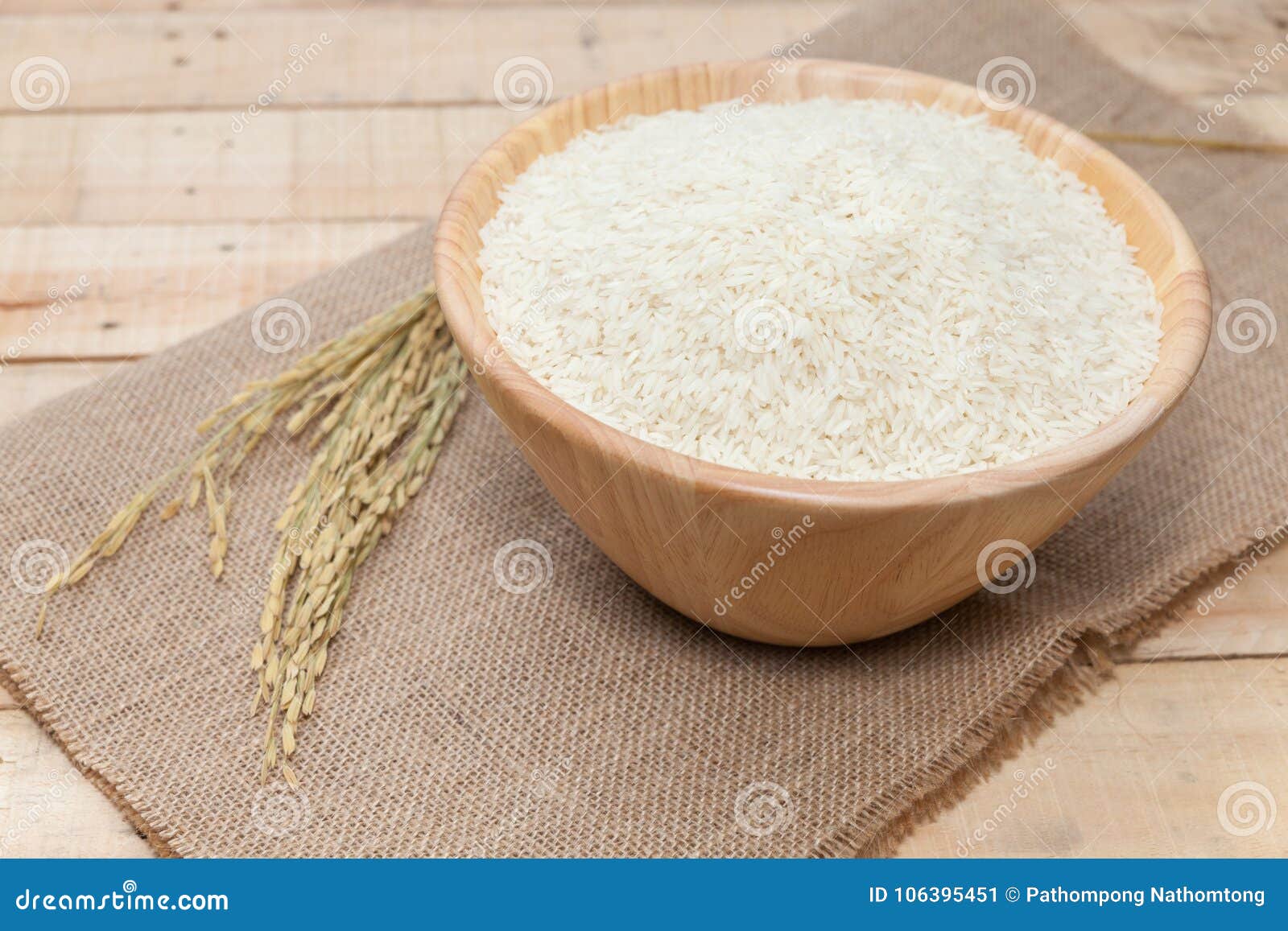 Raw rice in wooden bowl stock image. Image of cereal - 106395451