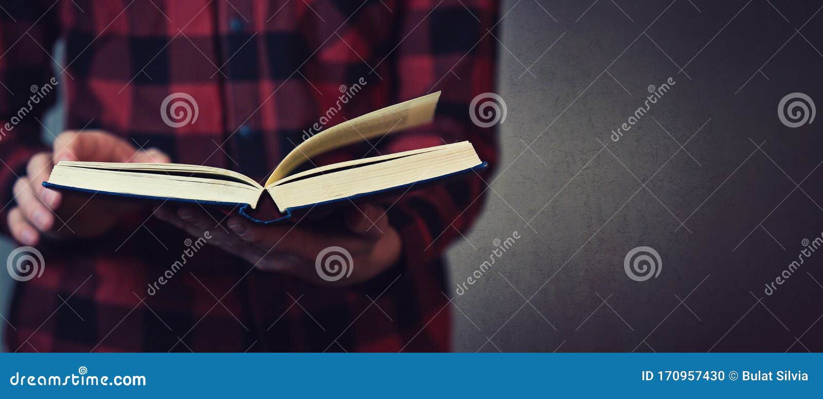 Close Up of Reader Hands Holding an Open Book Finding Information ...