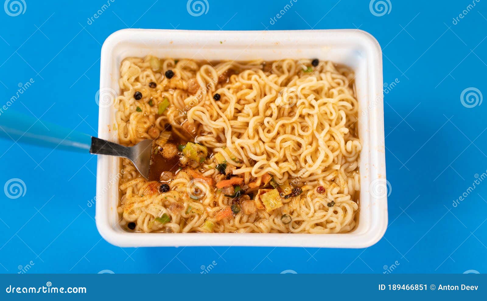 Close Up of Ready-made Instant Noodles with Spices and Fork on Blue ...
