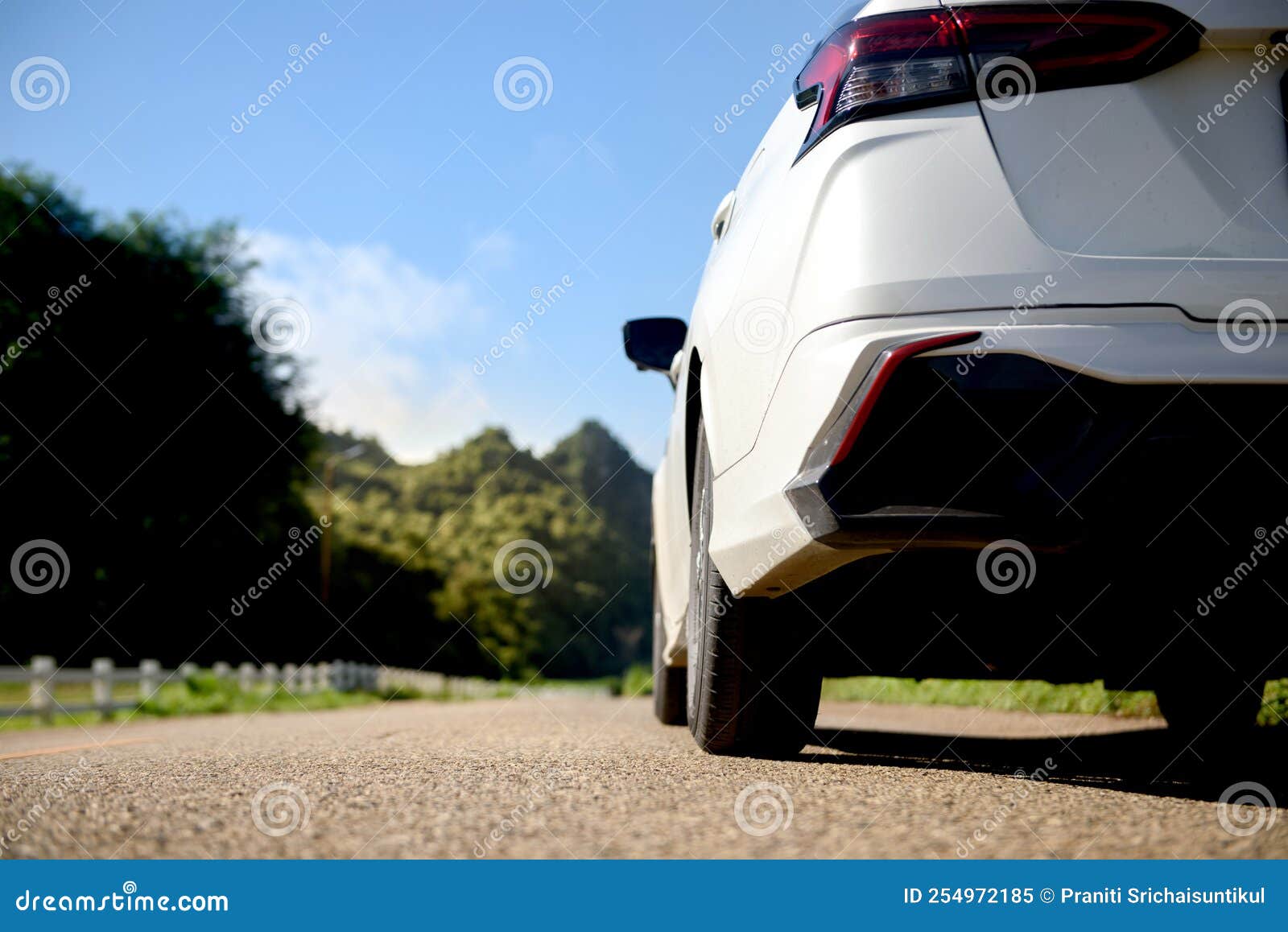 Close-up Rear View of a White Car with Mountains and Sky on the Road ...