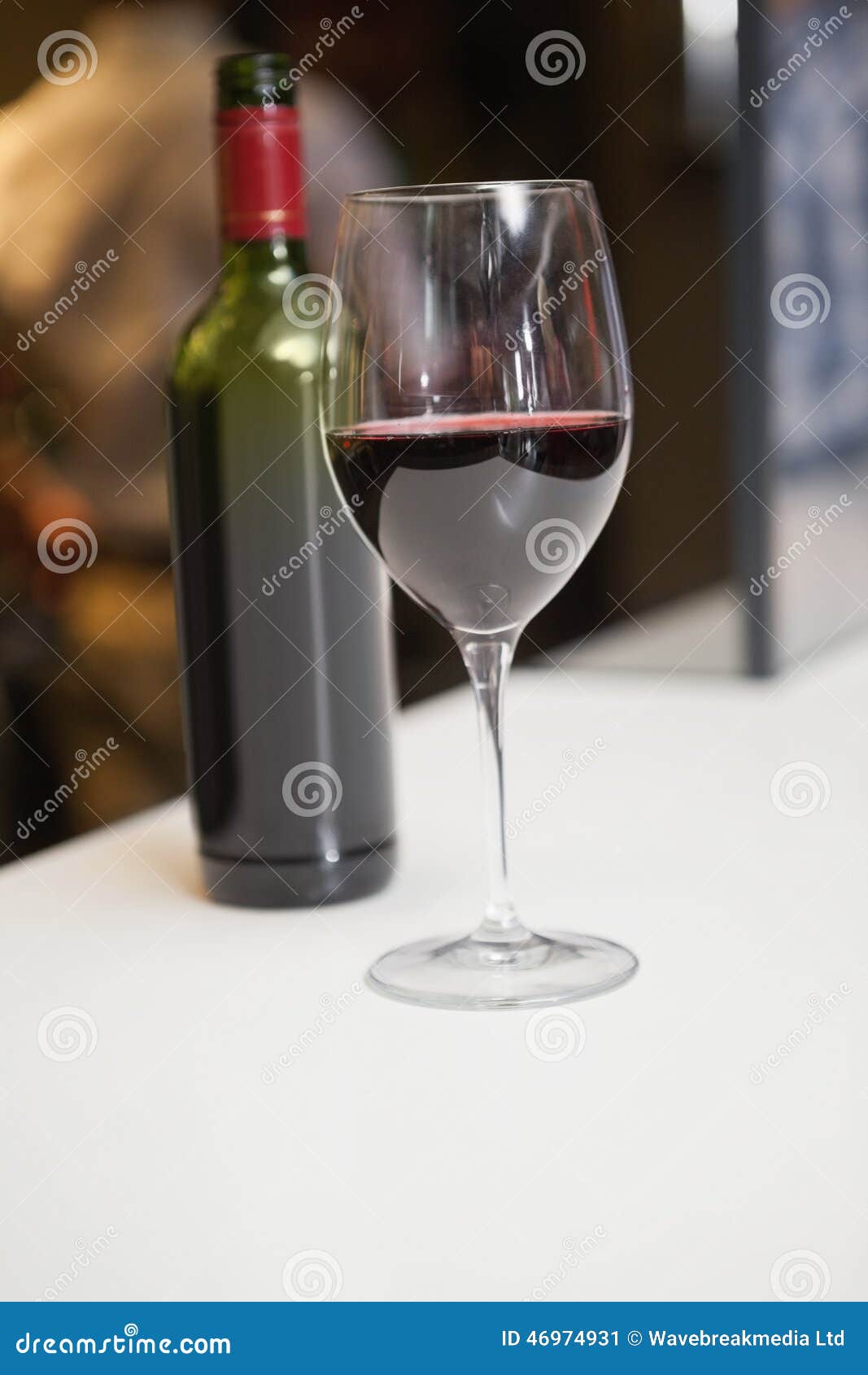 Close Up of Red Wine into Glass in Front of the Bottle Stock Image ...