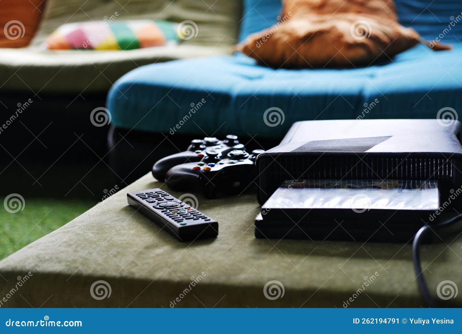 Close-up of Remote Control, Game Console and Disc Packaging on Table in ...