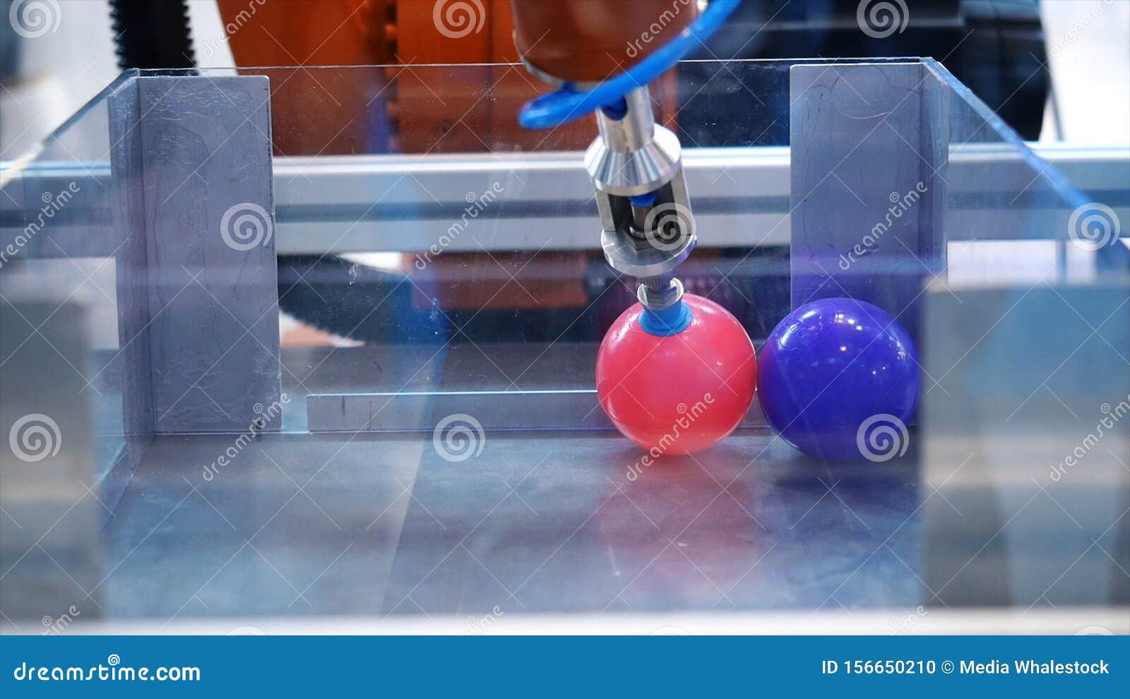 Close-up of Robotic Machine Hand Relocating Small Plastic Multicolored ...