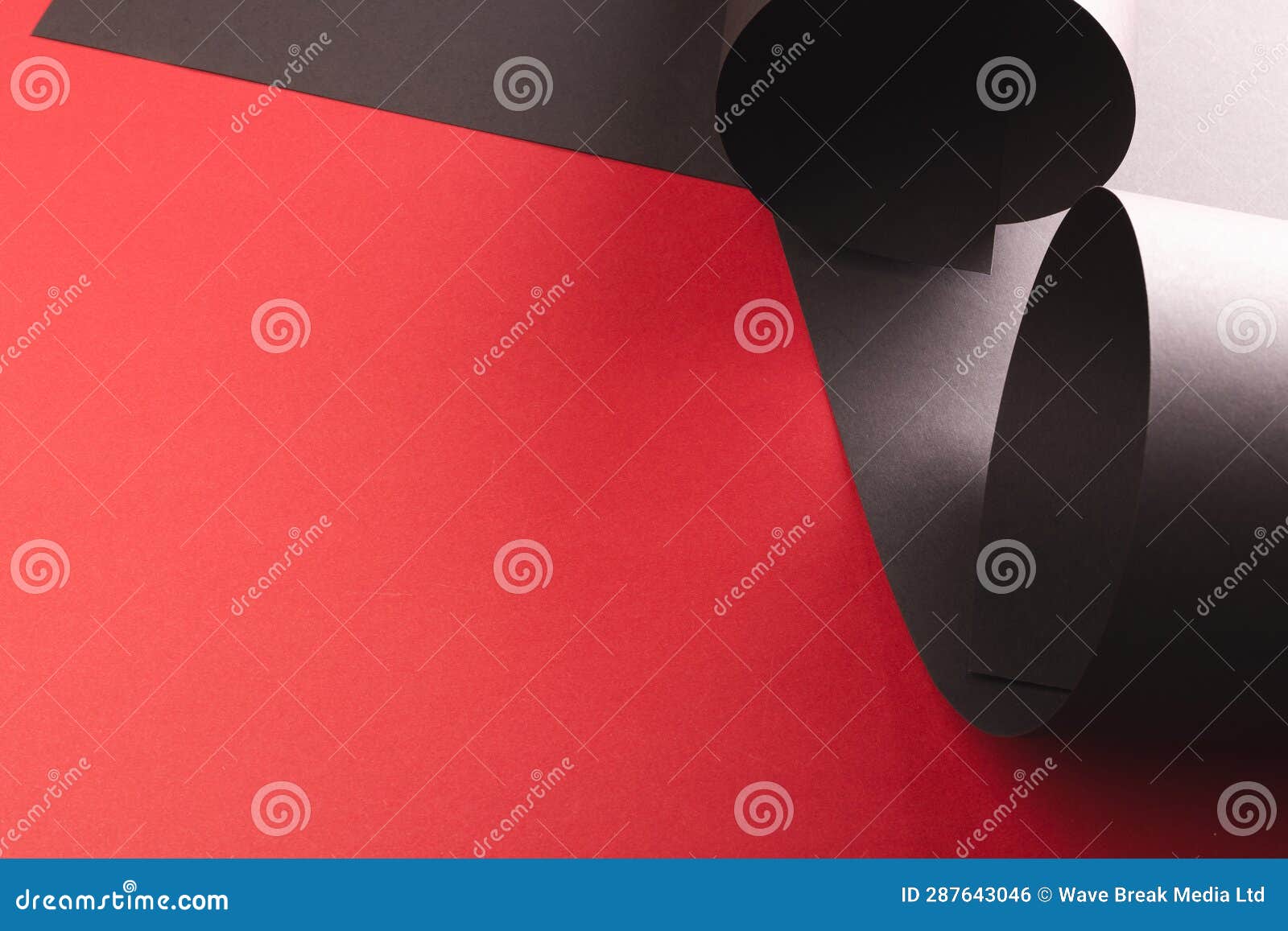 Close Up of Rolled Up Pieces of Black Paper with Copy Space on Red ...