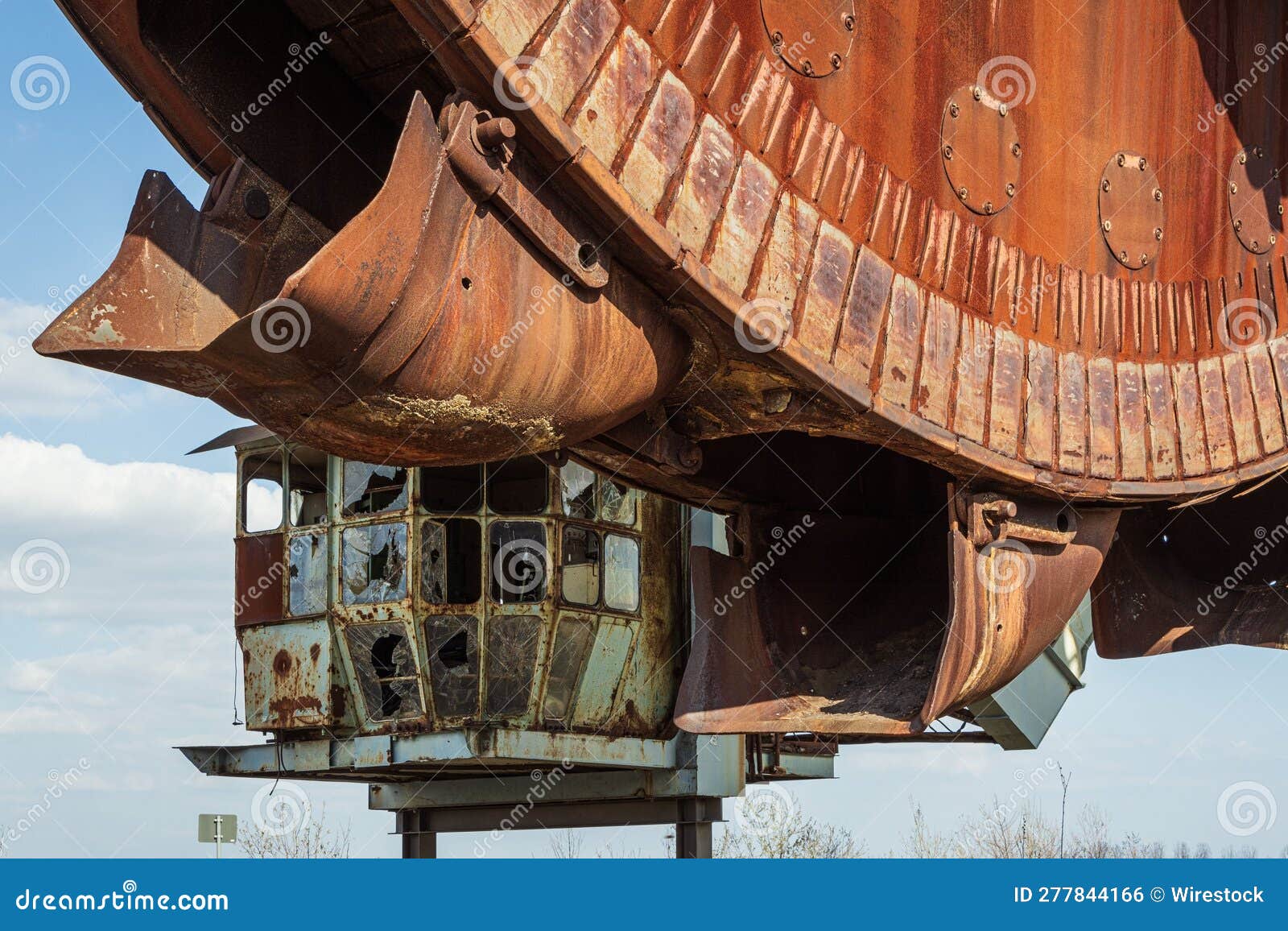 Close-up of a Rusty Old Excavator with Rust and a Clear Blue Sky in the ...