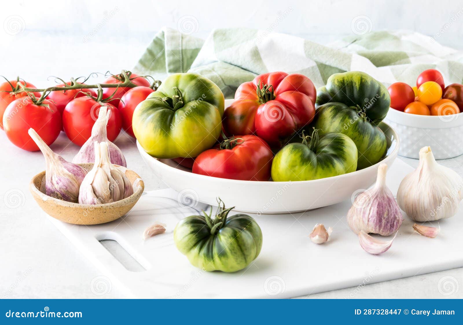 A Close Up Scene of Different Types of Tomatoes with Garlic Bulbs and ...
