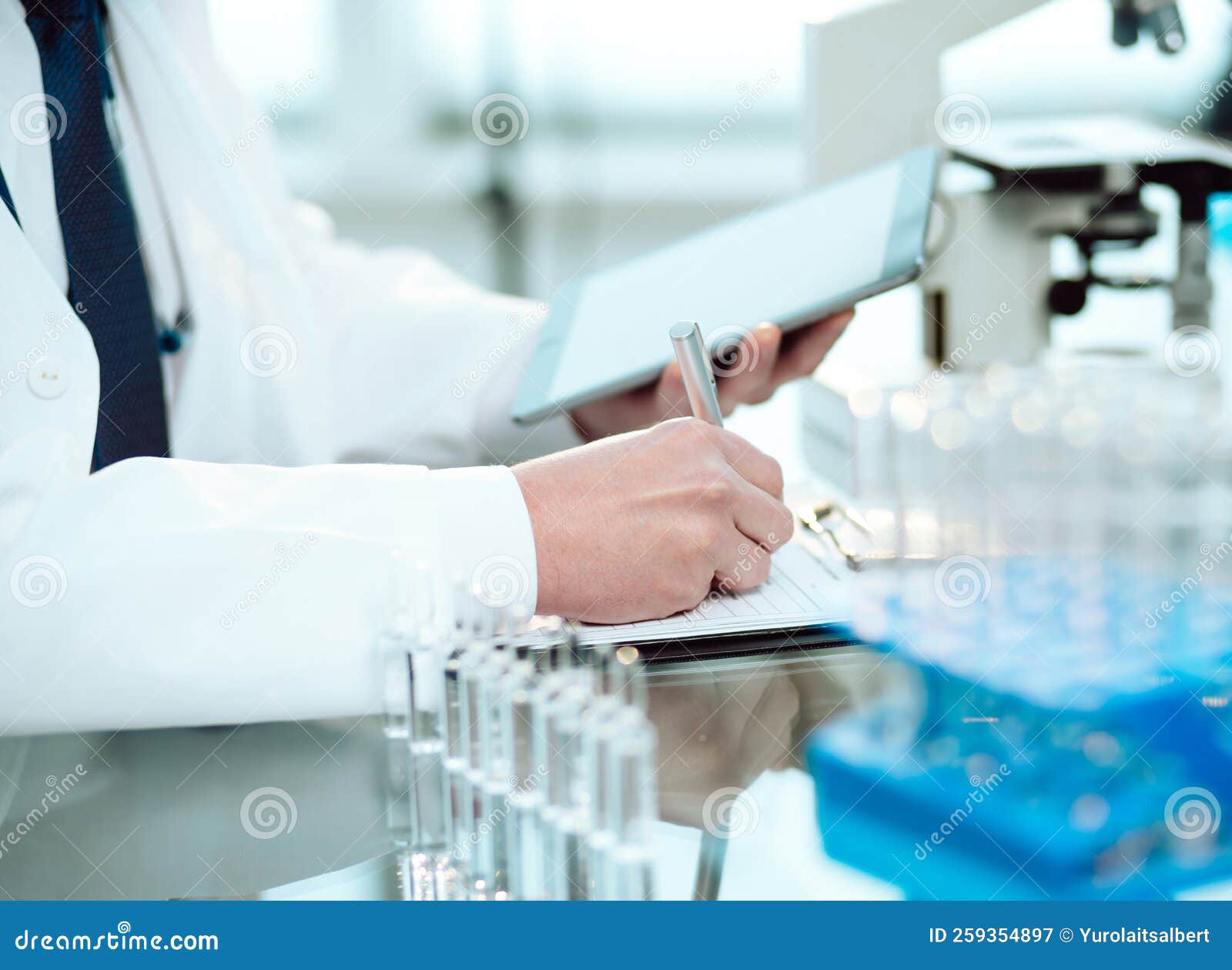Science Lab Technician with a Digital Tablet Making Notes on the ...