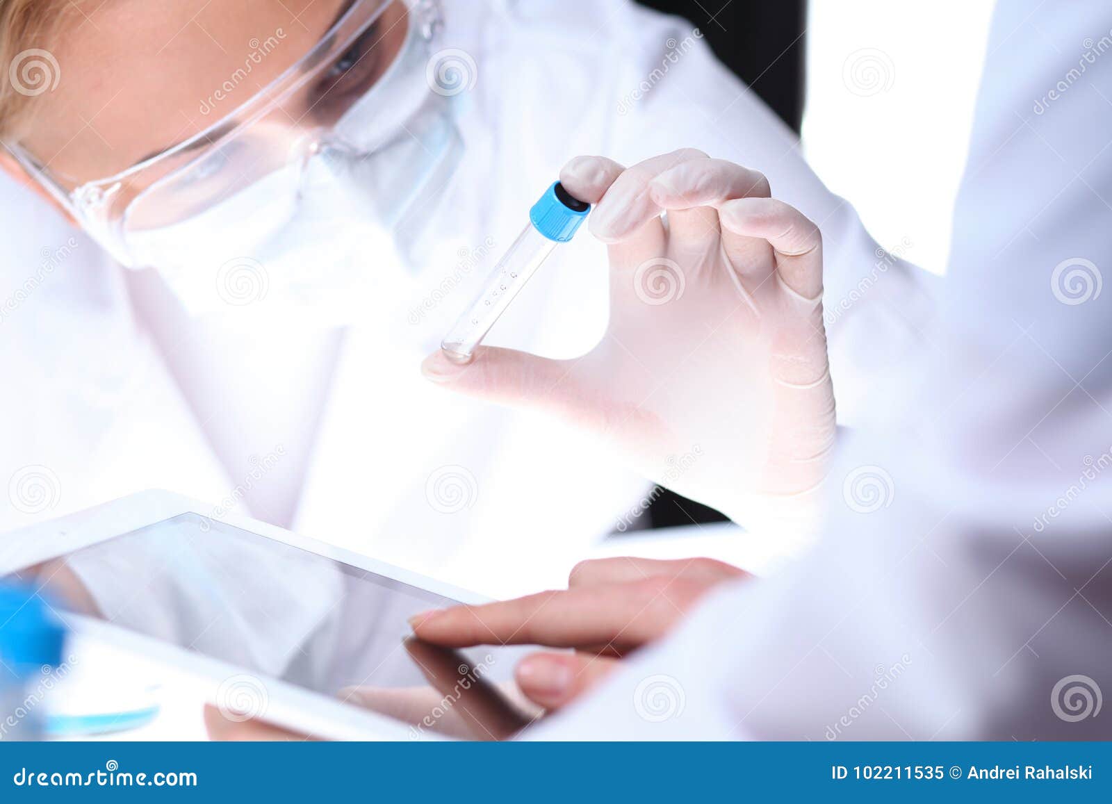 Close-up of Scientific Research Team with Clear Solution in Laboratory ...