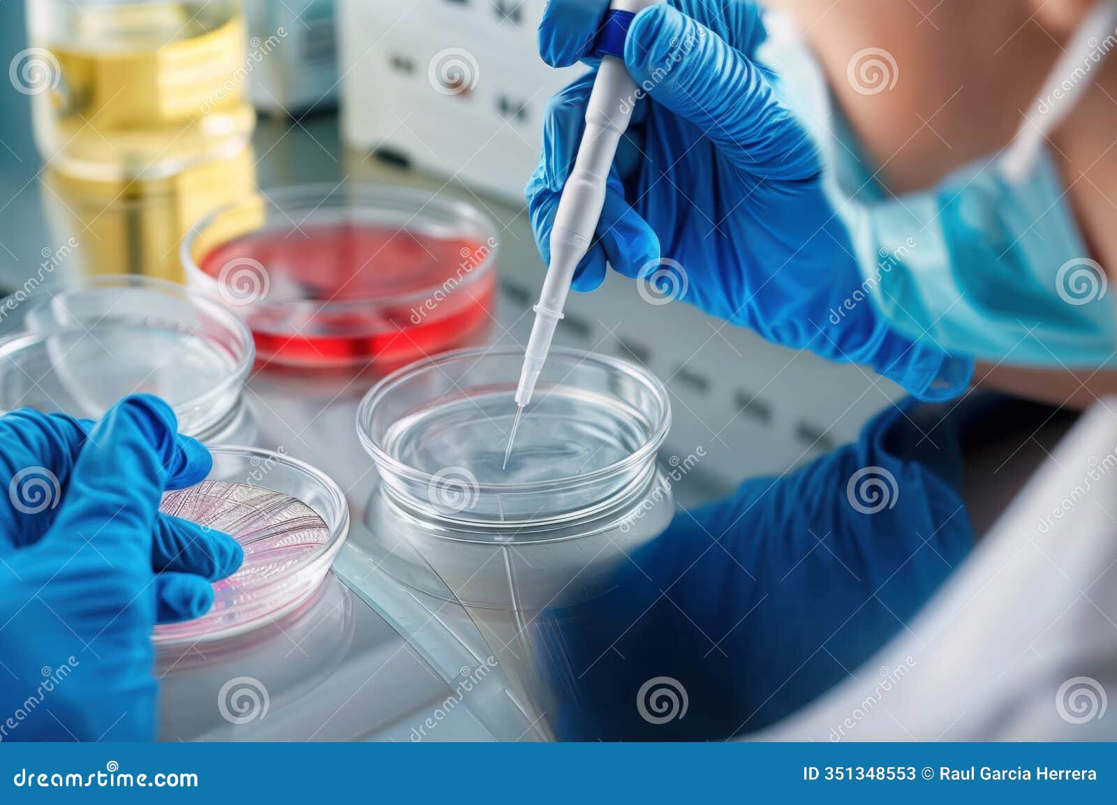 Close-up of Scientist Dripping Liquid into Petri Dish Using Pipette ...