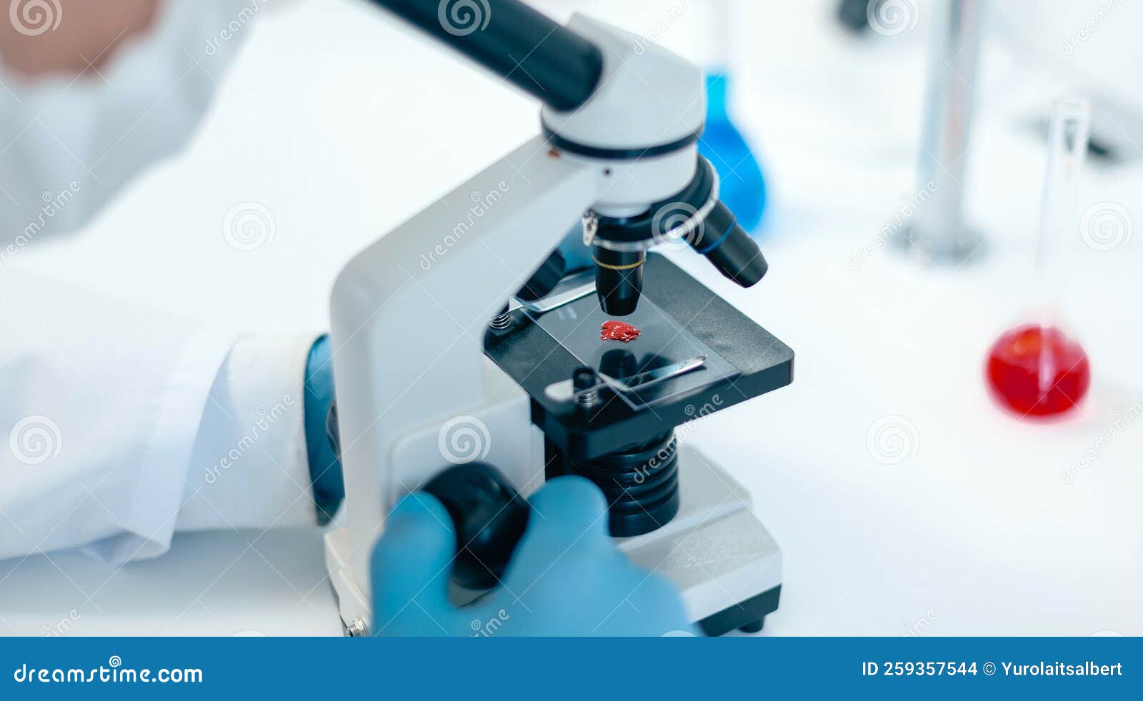 Close Up. Scientist Looking at a Drop of Blood through a Microscope ...