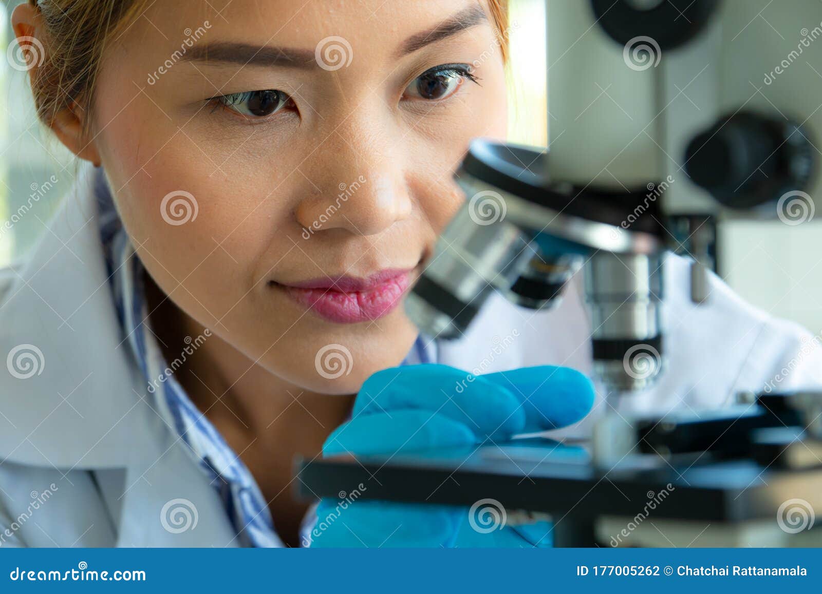 Close Up Scientist Looking Through A Microscope In A Laboratory ...
