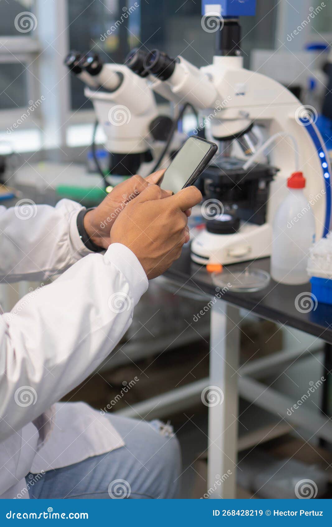 Close-up of a Scientist Using a Cell Phone in the Laboratory Stock ...