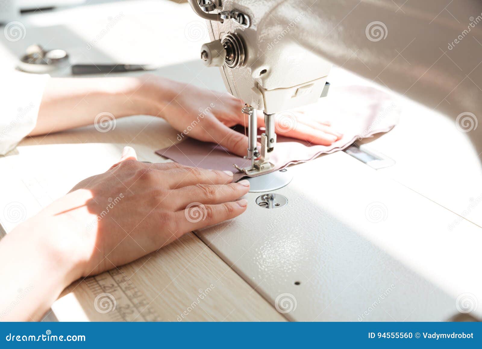Close-up Seamstress Hands Working On Sewing Machine At Home. Sewing ...