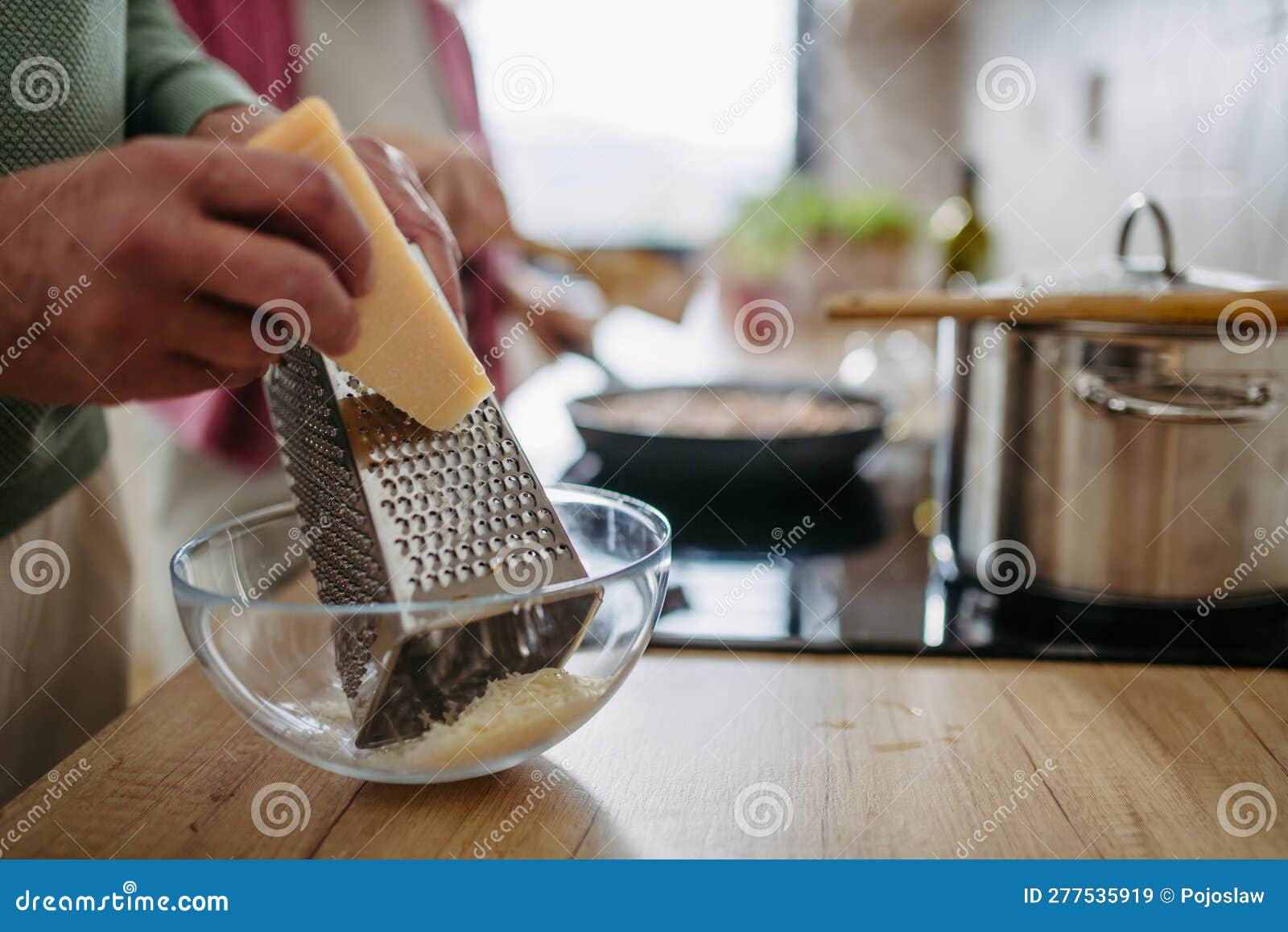 Close Up of Senior Man Grating Cheese during Cooking. Stock Image ...