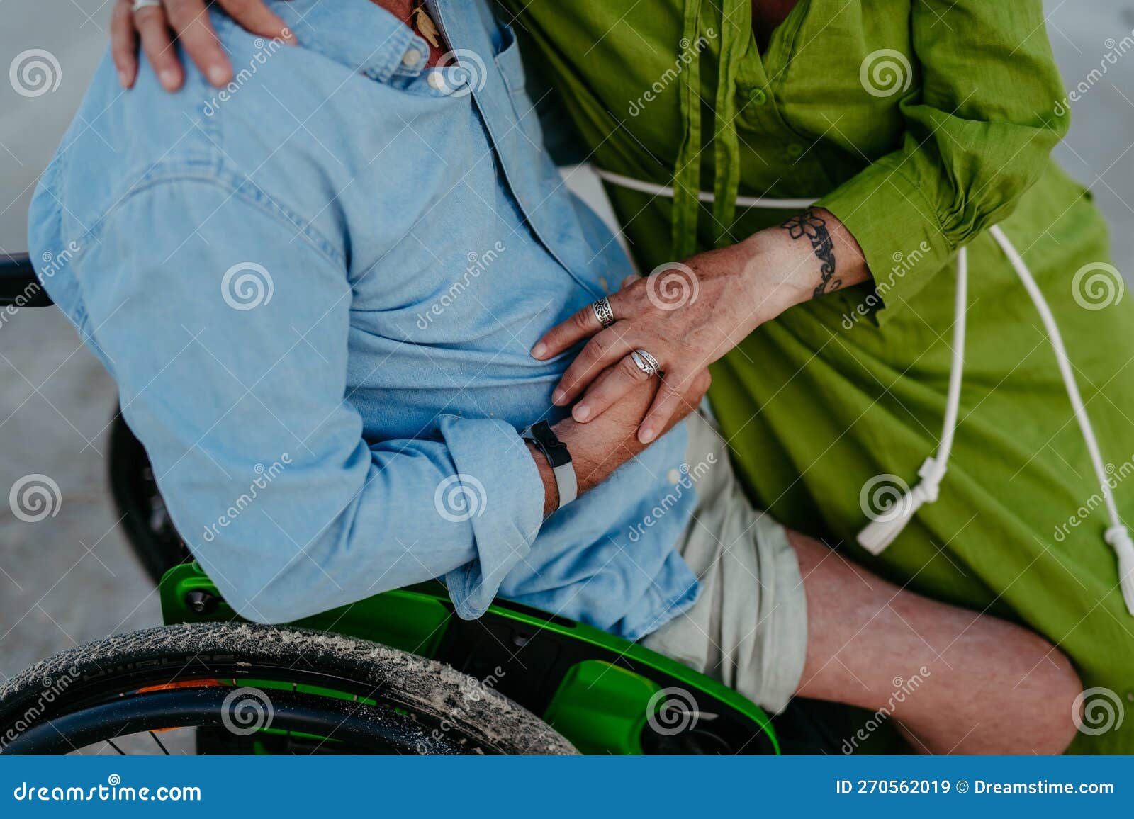 Close Up Of Senior Man On Wheelchair Enjoying Together Time With His