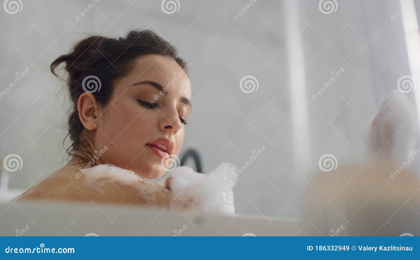 Close Up Sensual Woman Blowing Foam In Bathtub Slow Motion Stock Image