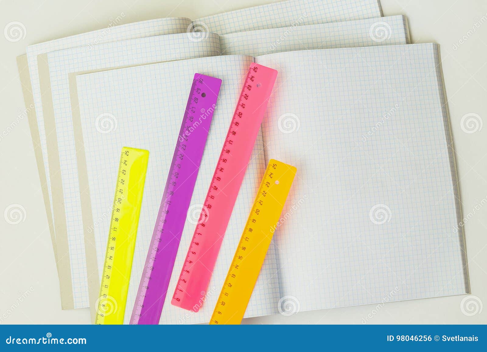 Close-up of a Set of Colored Rulers on a Background of Large Open Blank ...
